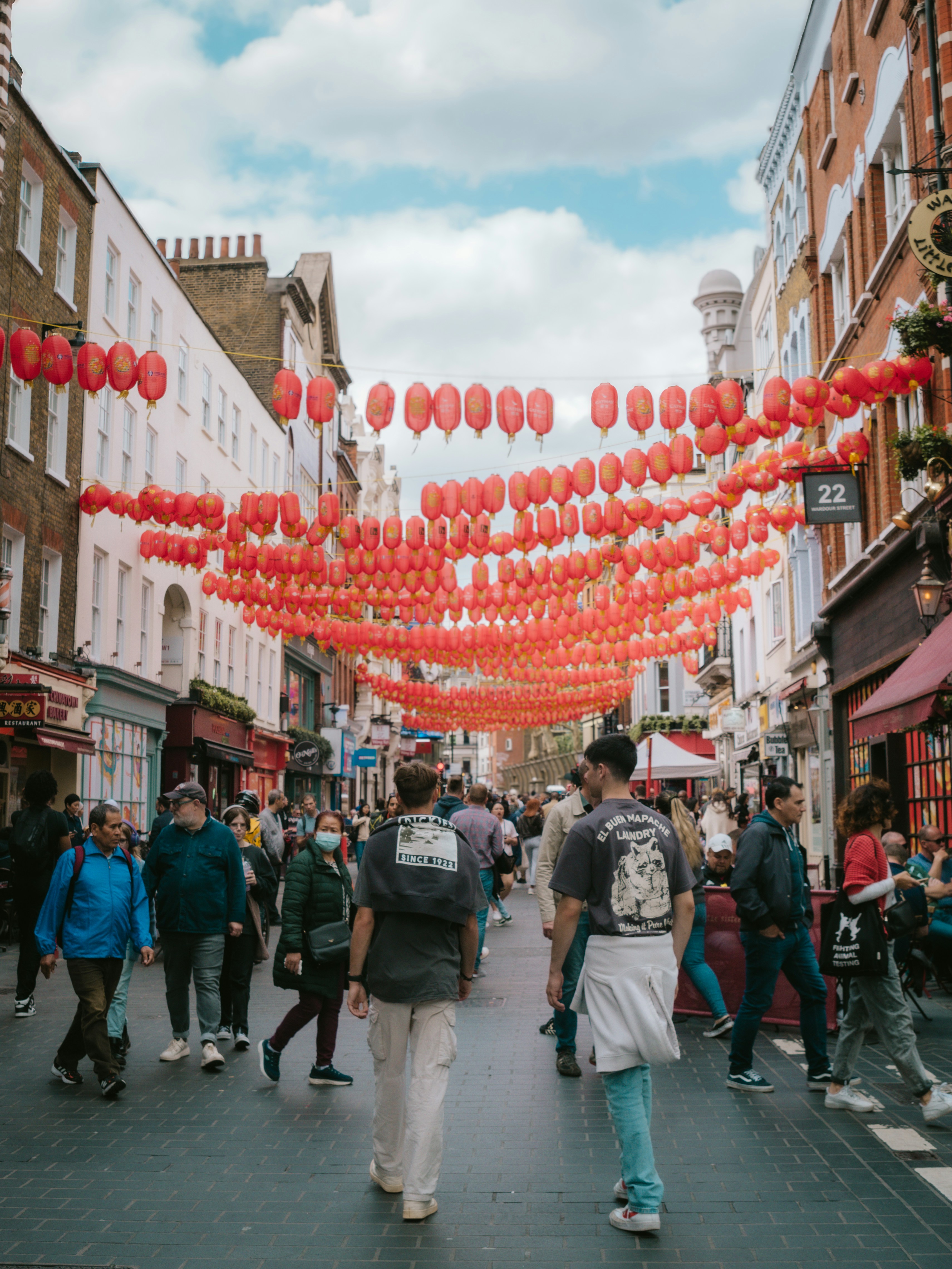 Lantern-lit Lane: A Bustling City Street Adorned with Red Orbs