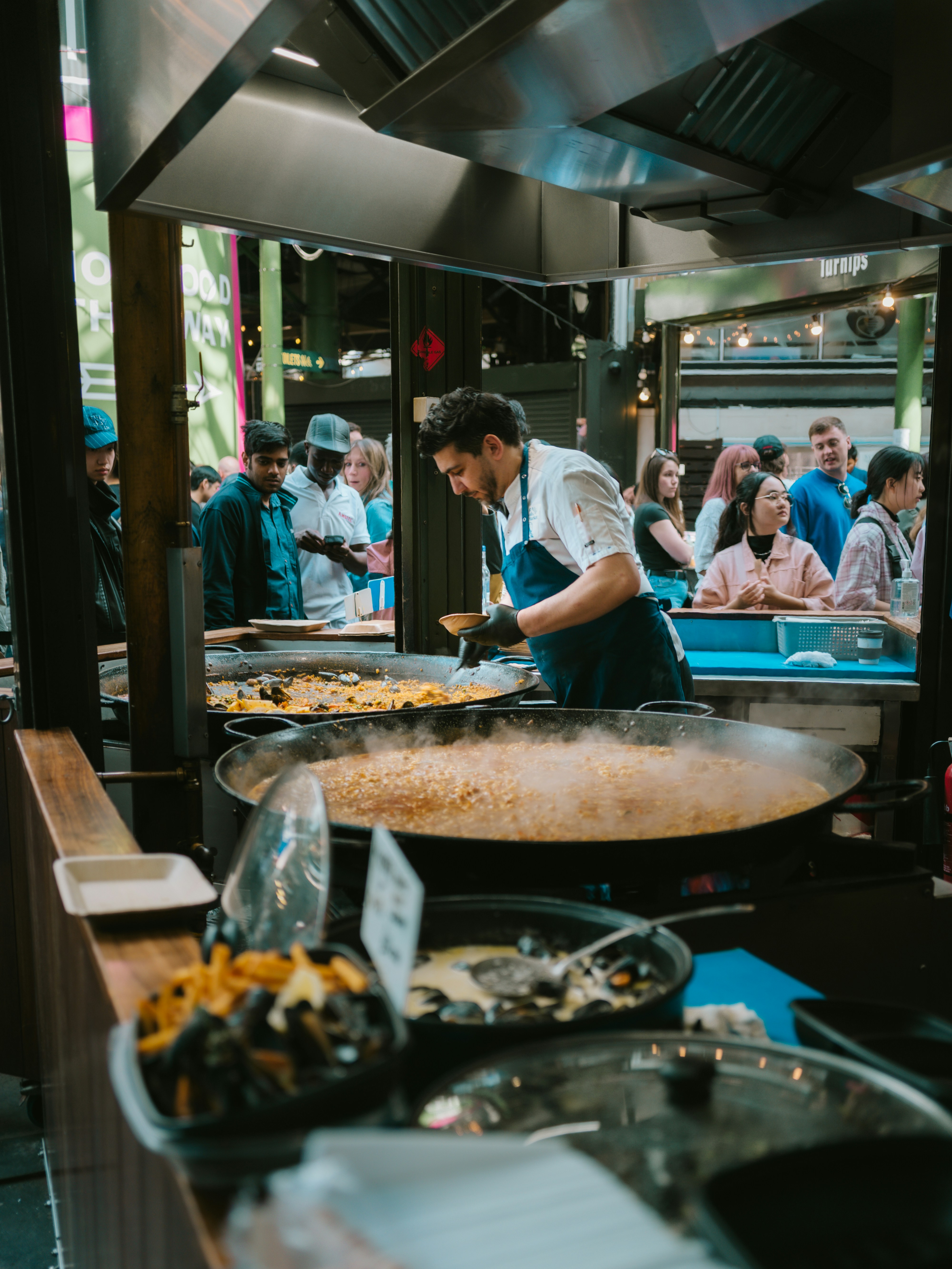 Flaming skillet at a bustling street-food stall