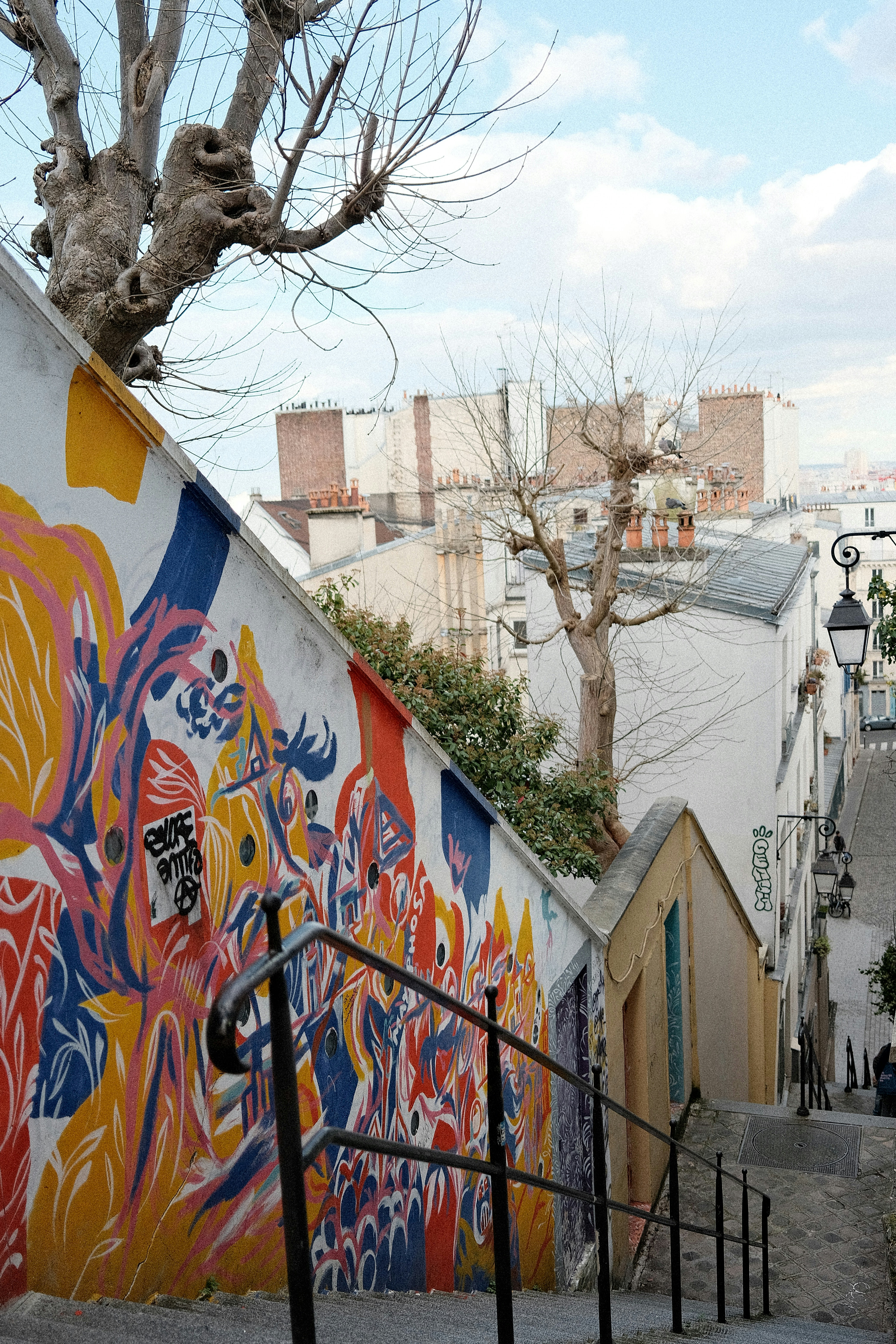 Colorful Staircase to the City: Graffiti Walls and Rooftop Vistas