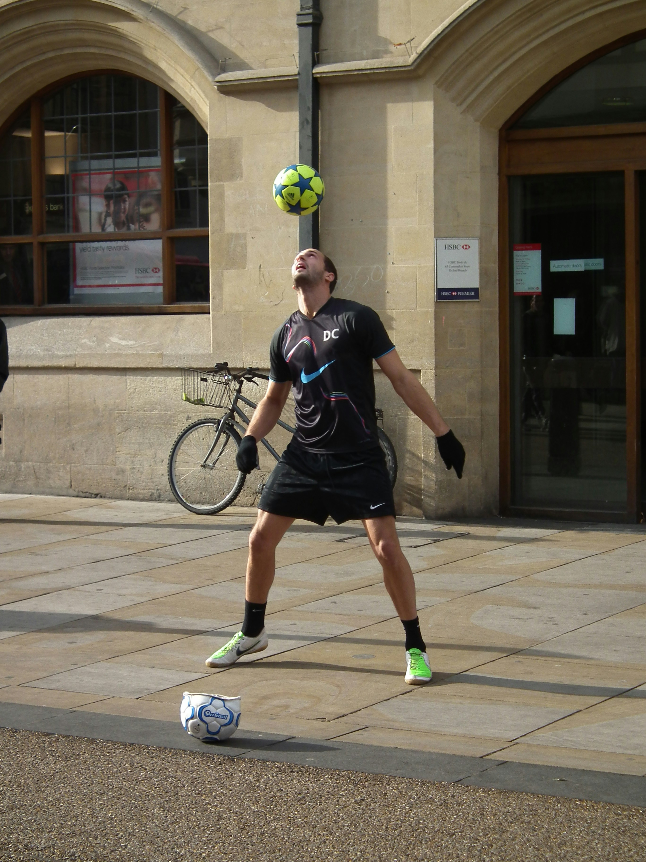 Balancing Act: A Solo Juggle on a Sunlit City Plaza