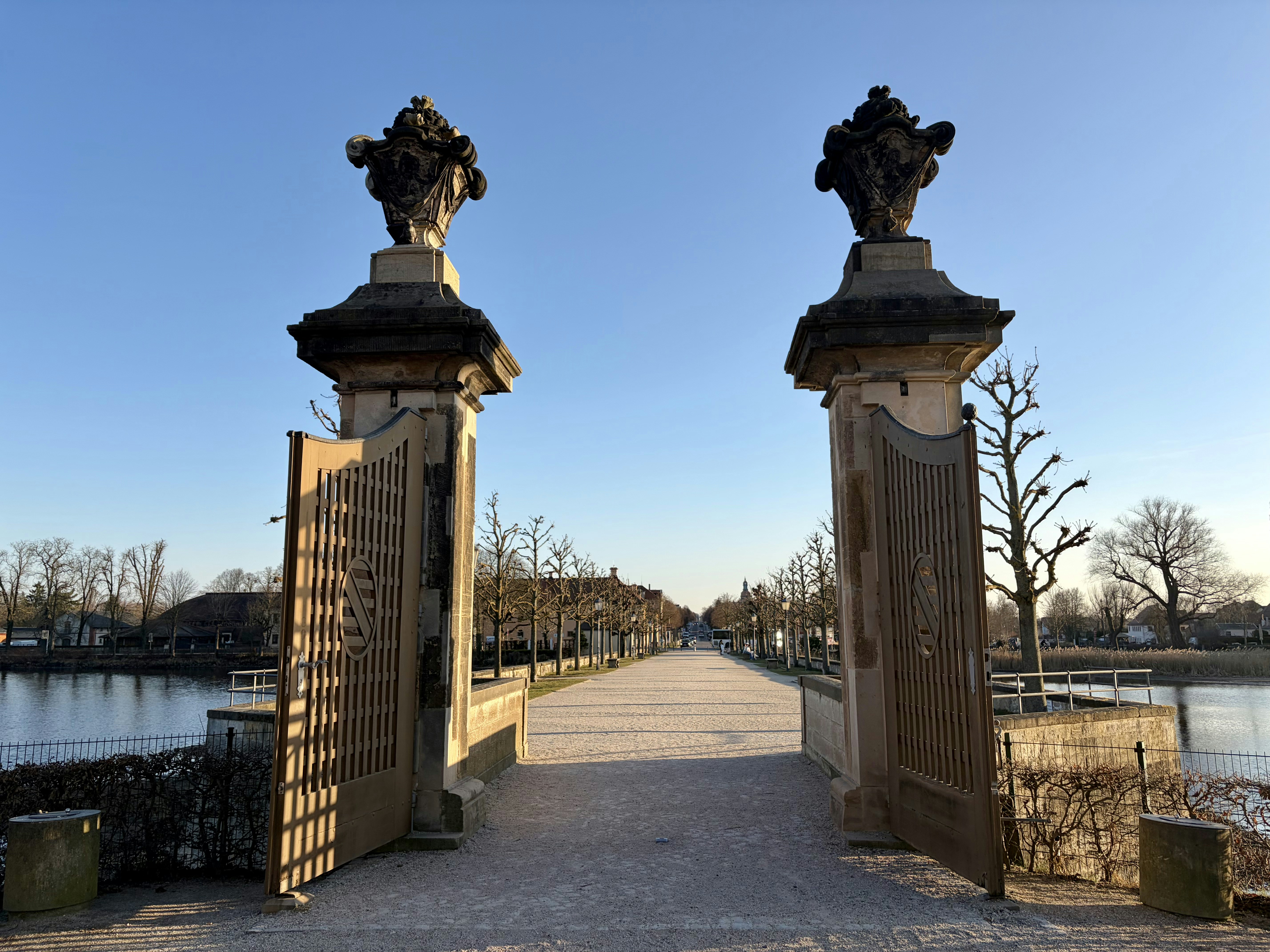Doorway to the Distance: Gates Open onto a Quiet Waterway