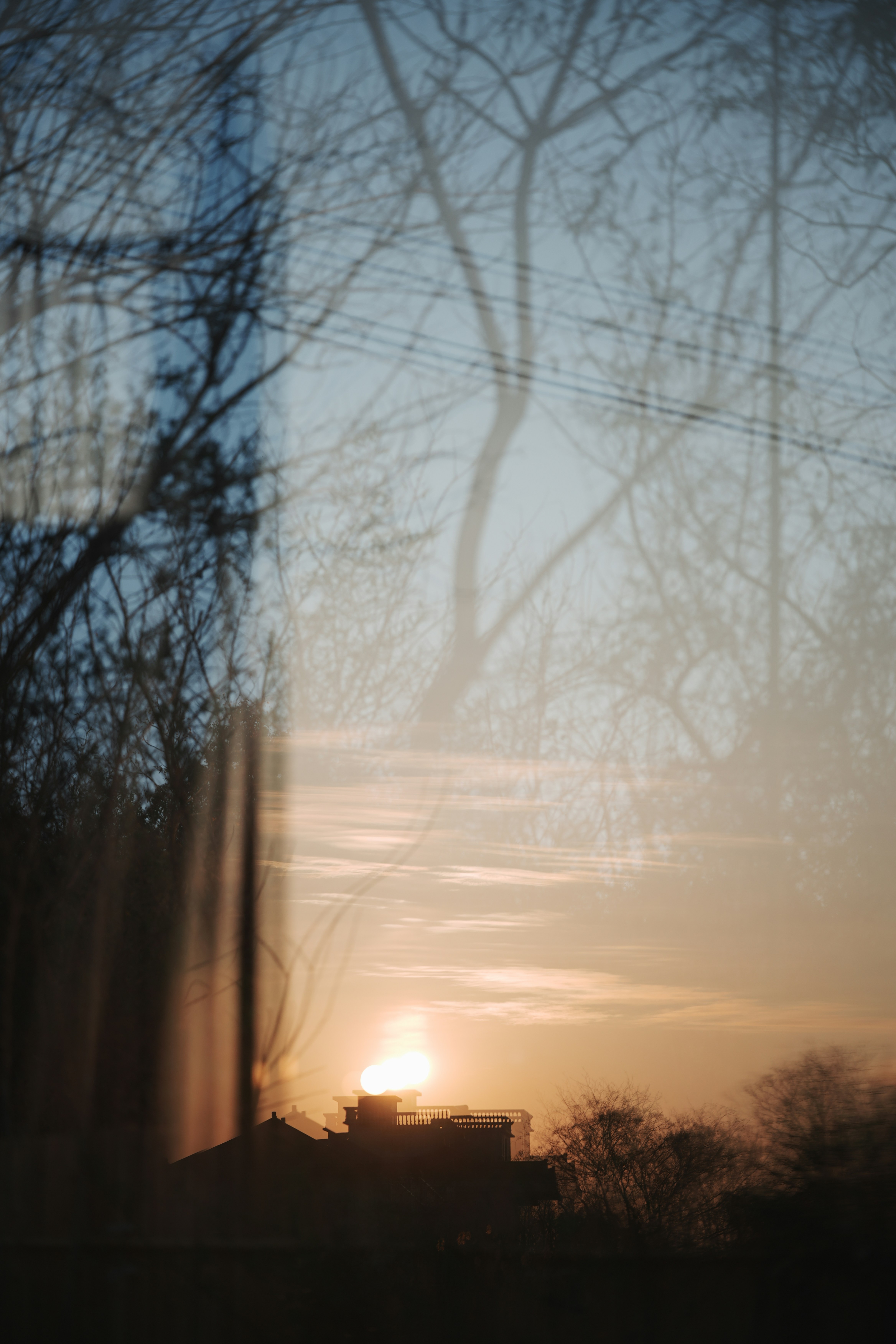 Sunset Veil Over Quiet Rooftops with a Glassy Reflection