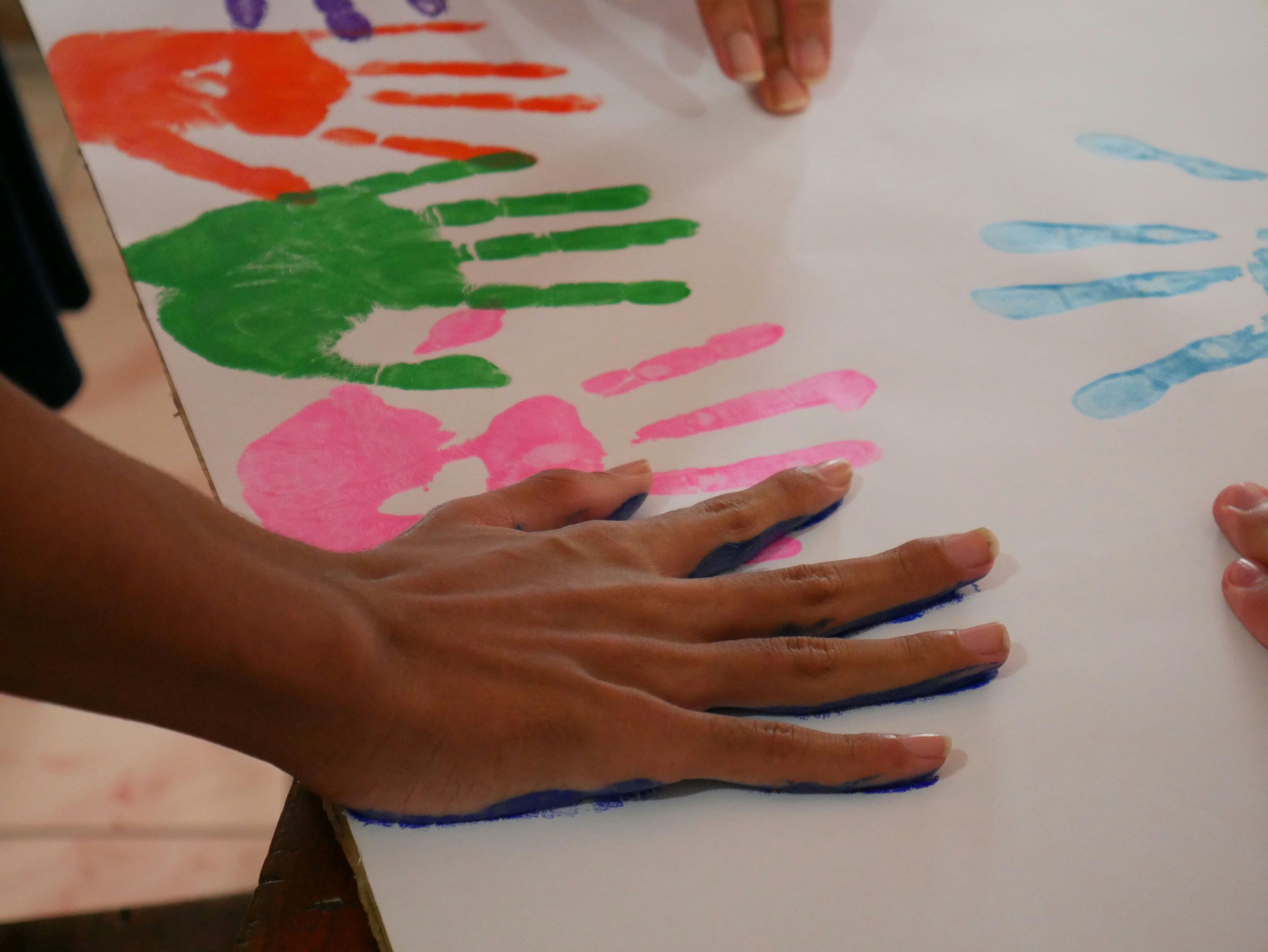 Bright Handprints: Colorful Imprint on White Paper