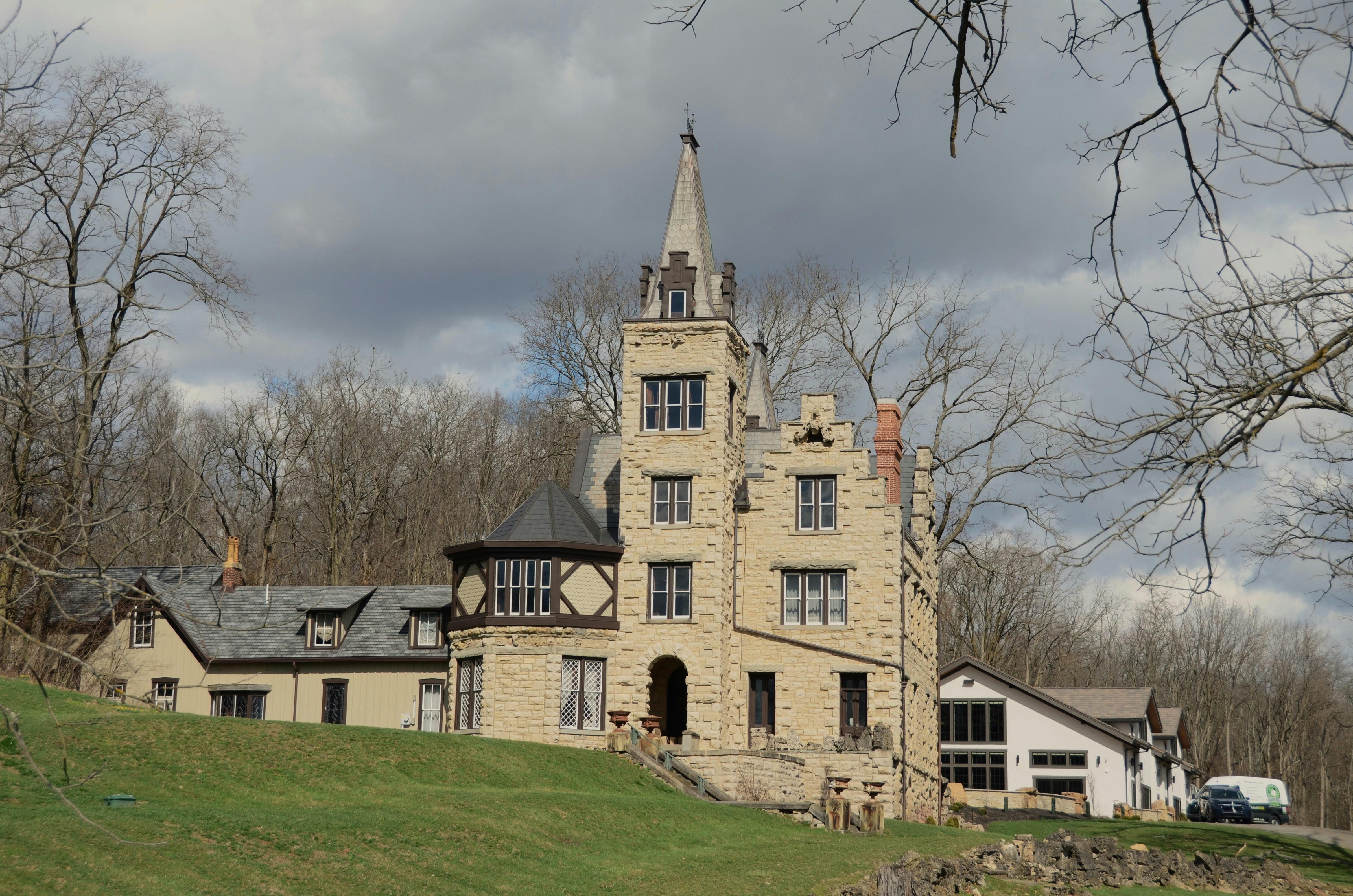 Stone Manor on a Gentle Slope under a Cloudy Sky
