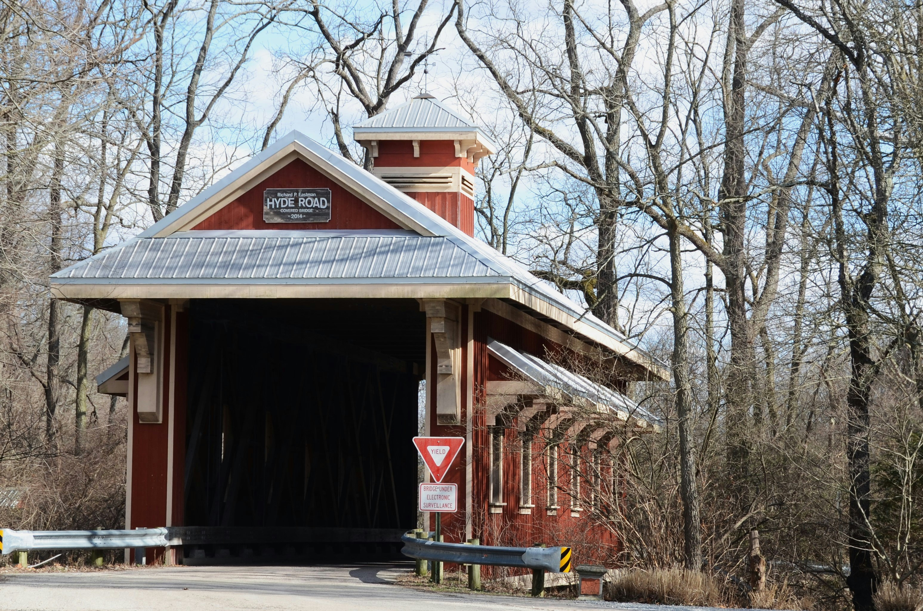 Red Covered Bridge at the Edge of Winter Woods