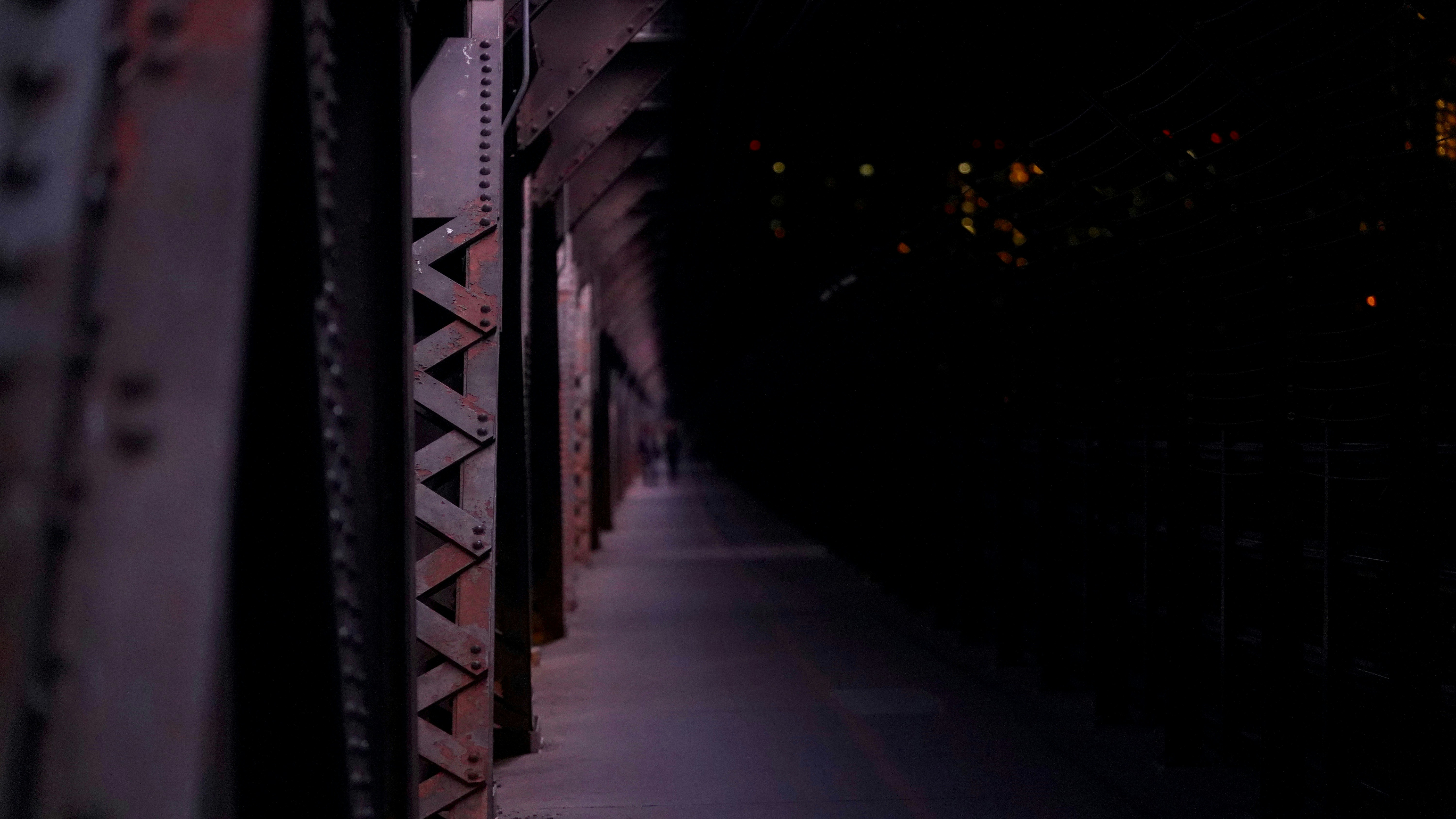 Shadowed Rail Corridor: A Distant Line of Steel and Light