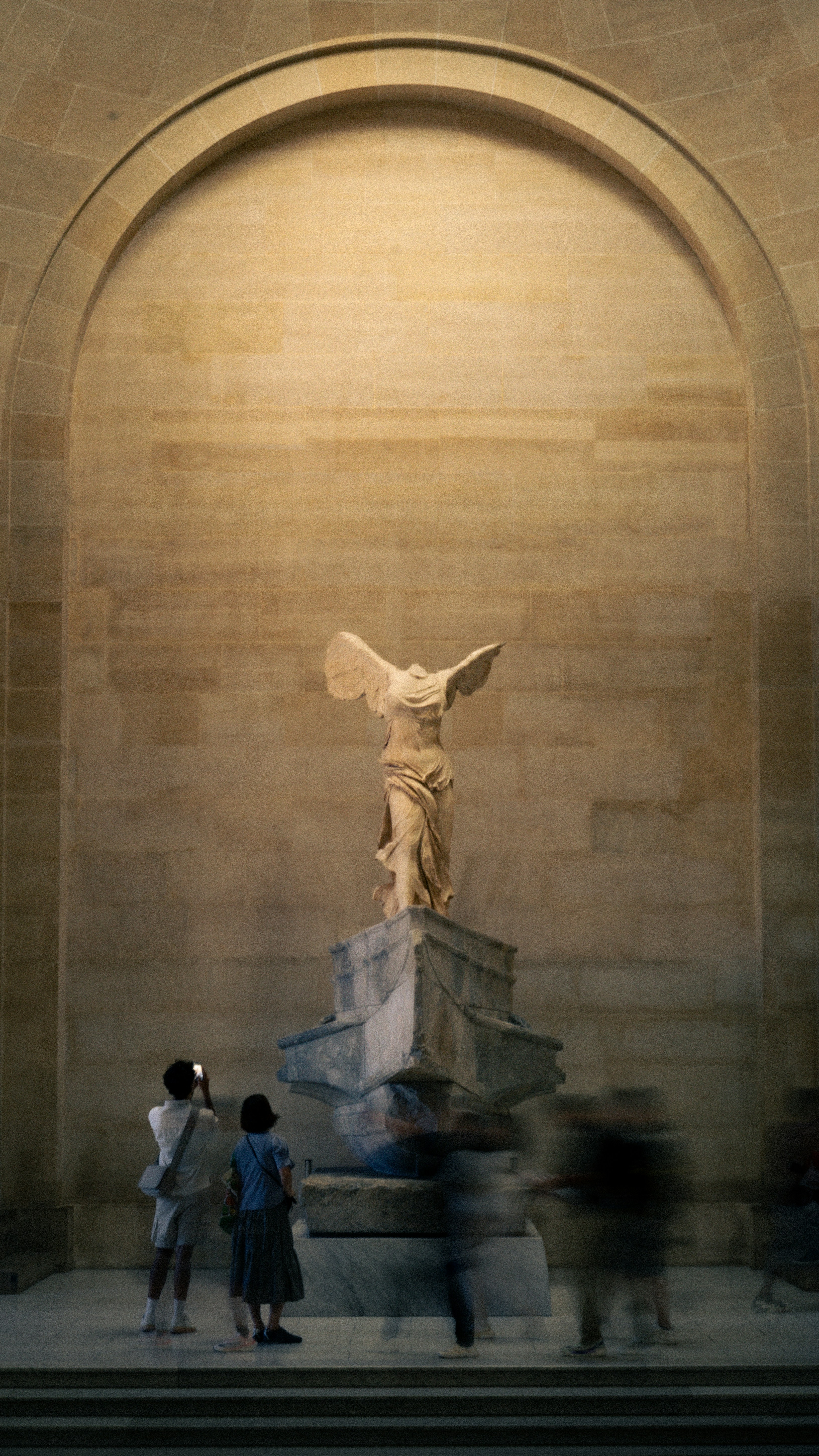 Winged Sculpture under Arch: Quiet Moments by a Monument