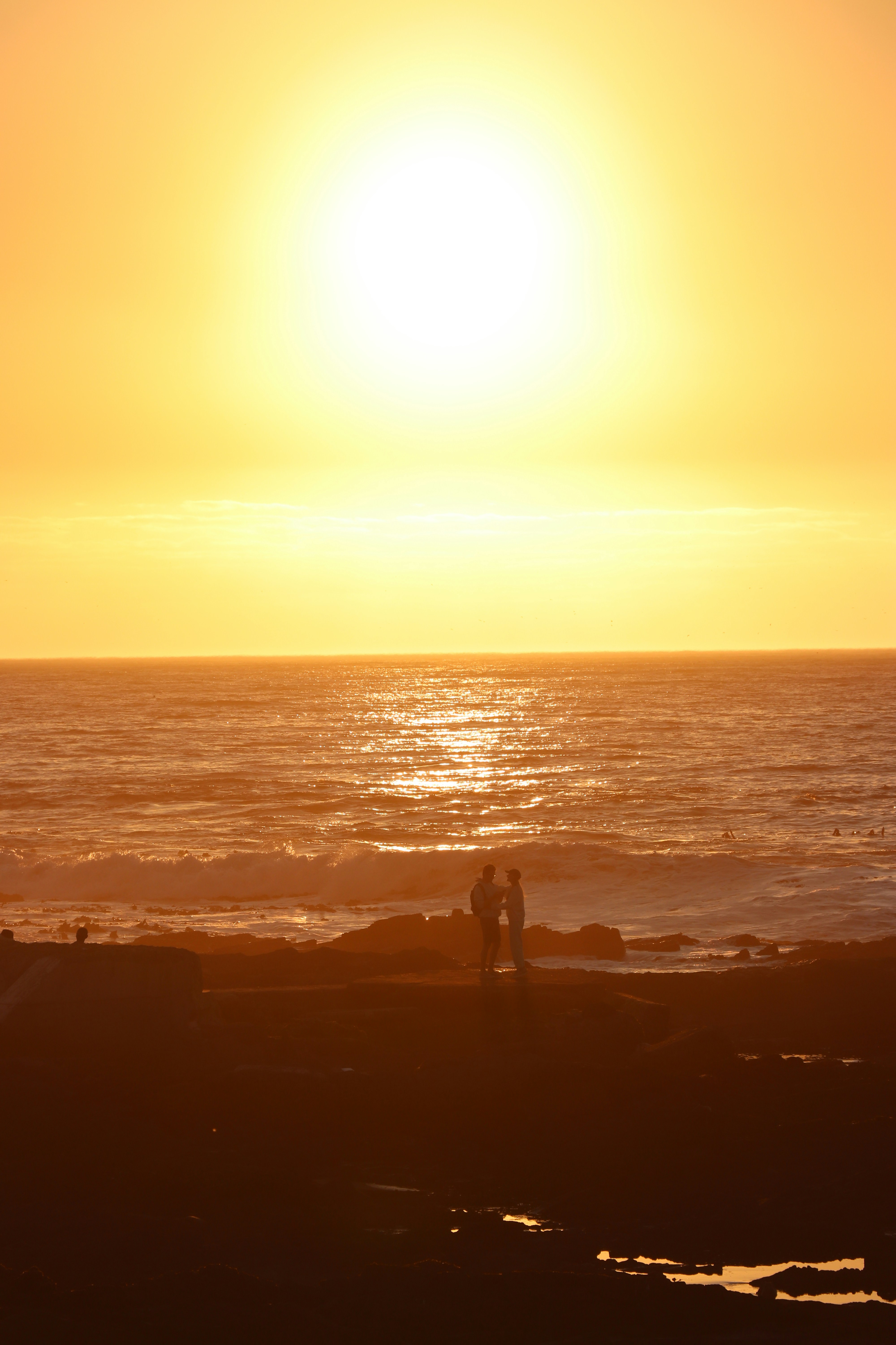 Sunlit Shoreline: A Silhouette at Dusk