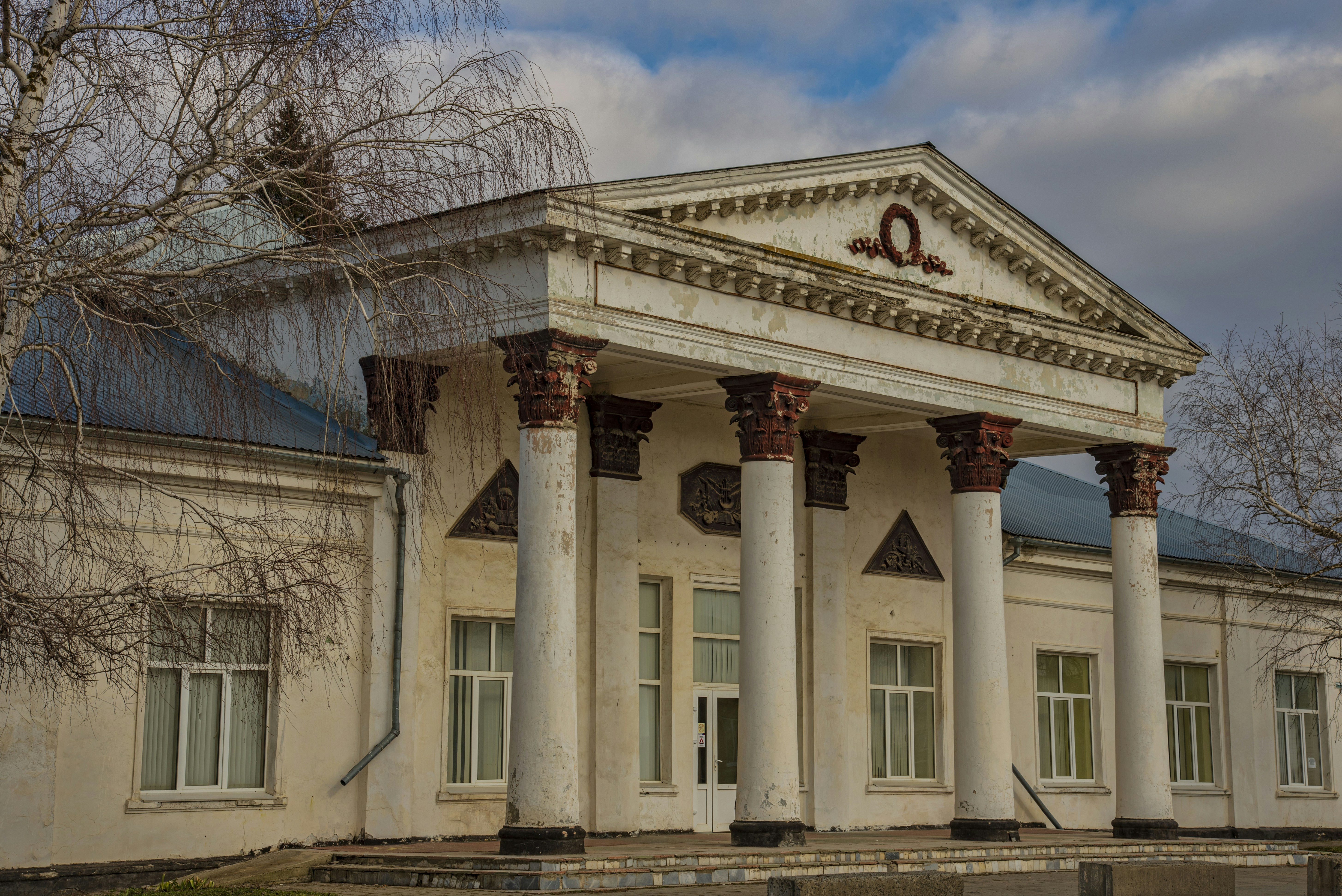 Classical Facade: Weathered Columns Guarding a Quiet Entrance