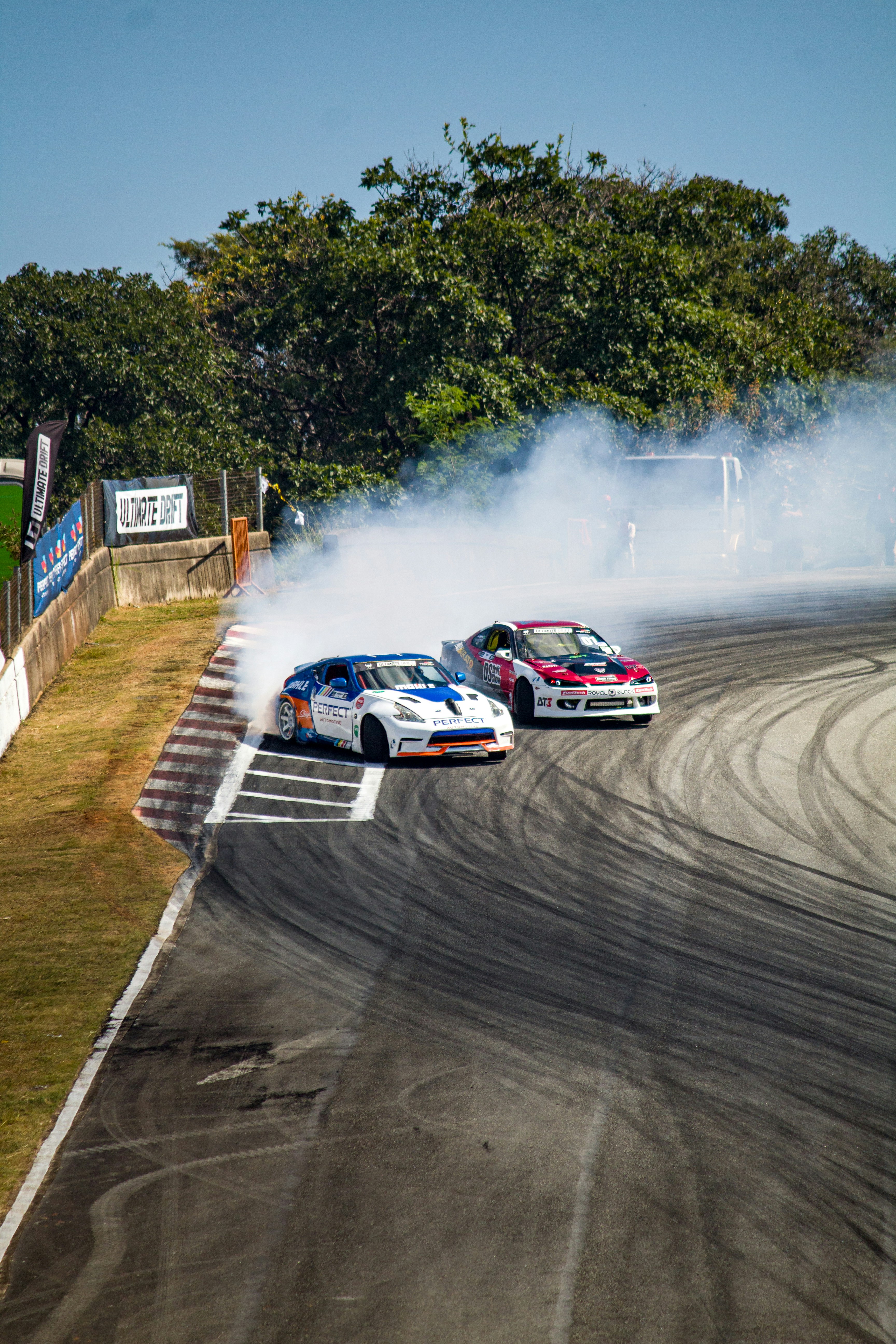Sliding Side by Side: Blue and Red Race Cars Drift into the Turn