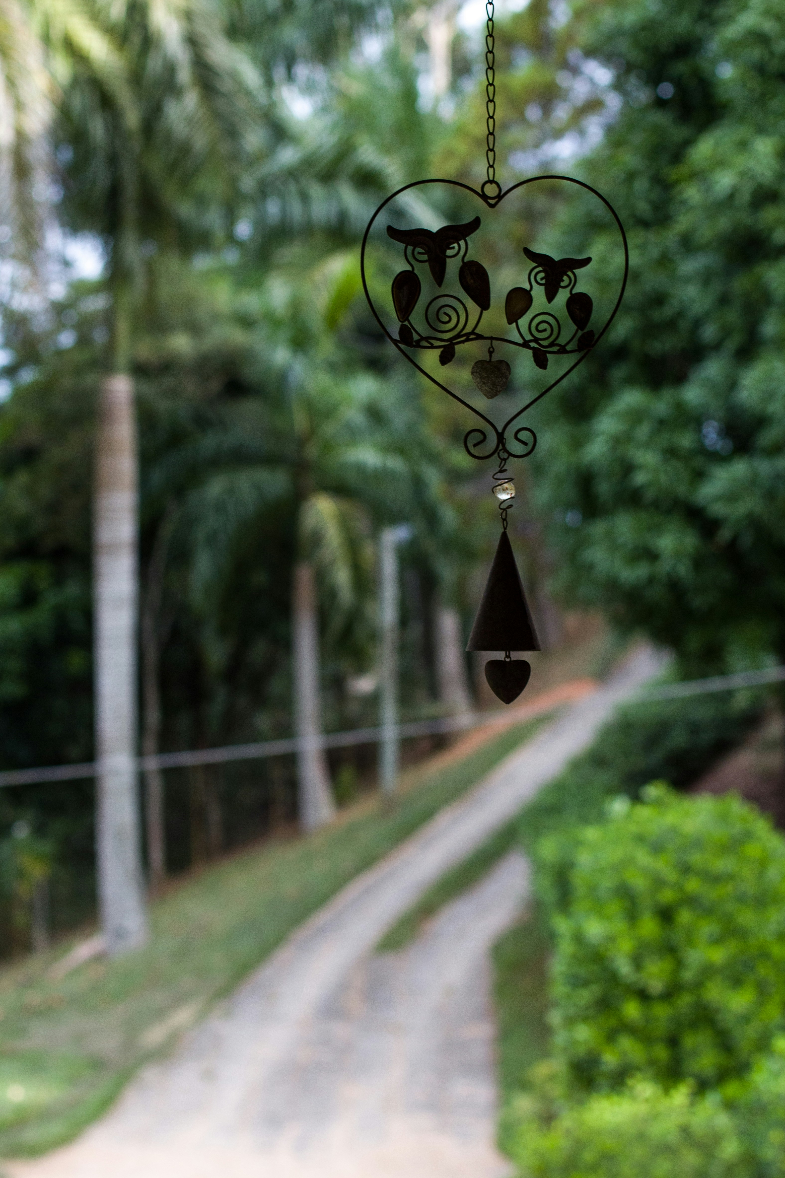 Heart of Stillness: Wind-Chime Silhouette Over a Quiet Path