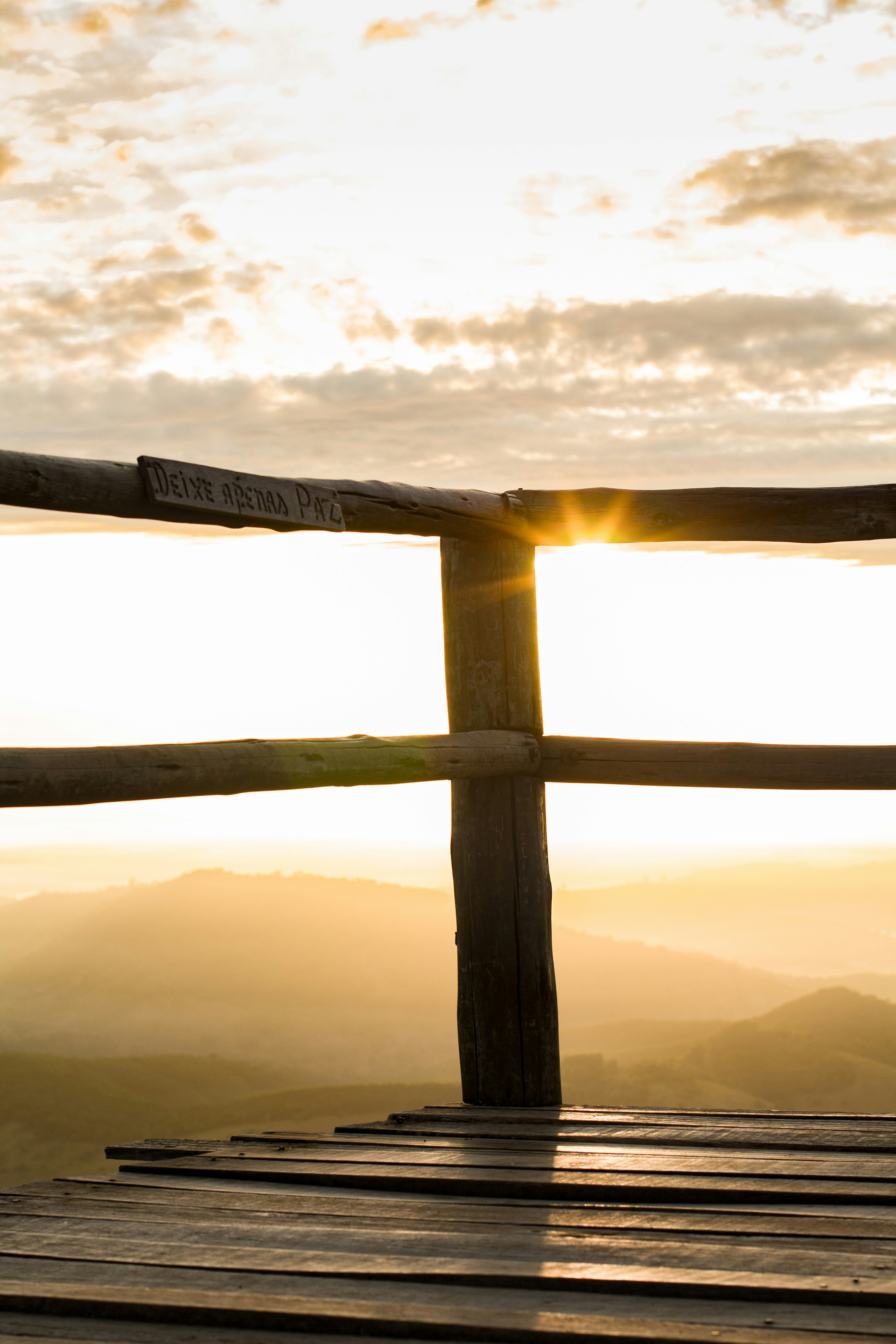 Sunburst over the Wooden Balcony: A Quiet Perch at Dawn
