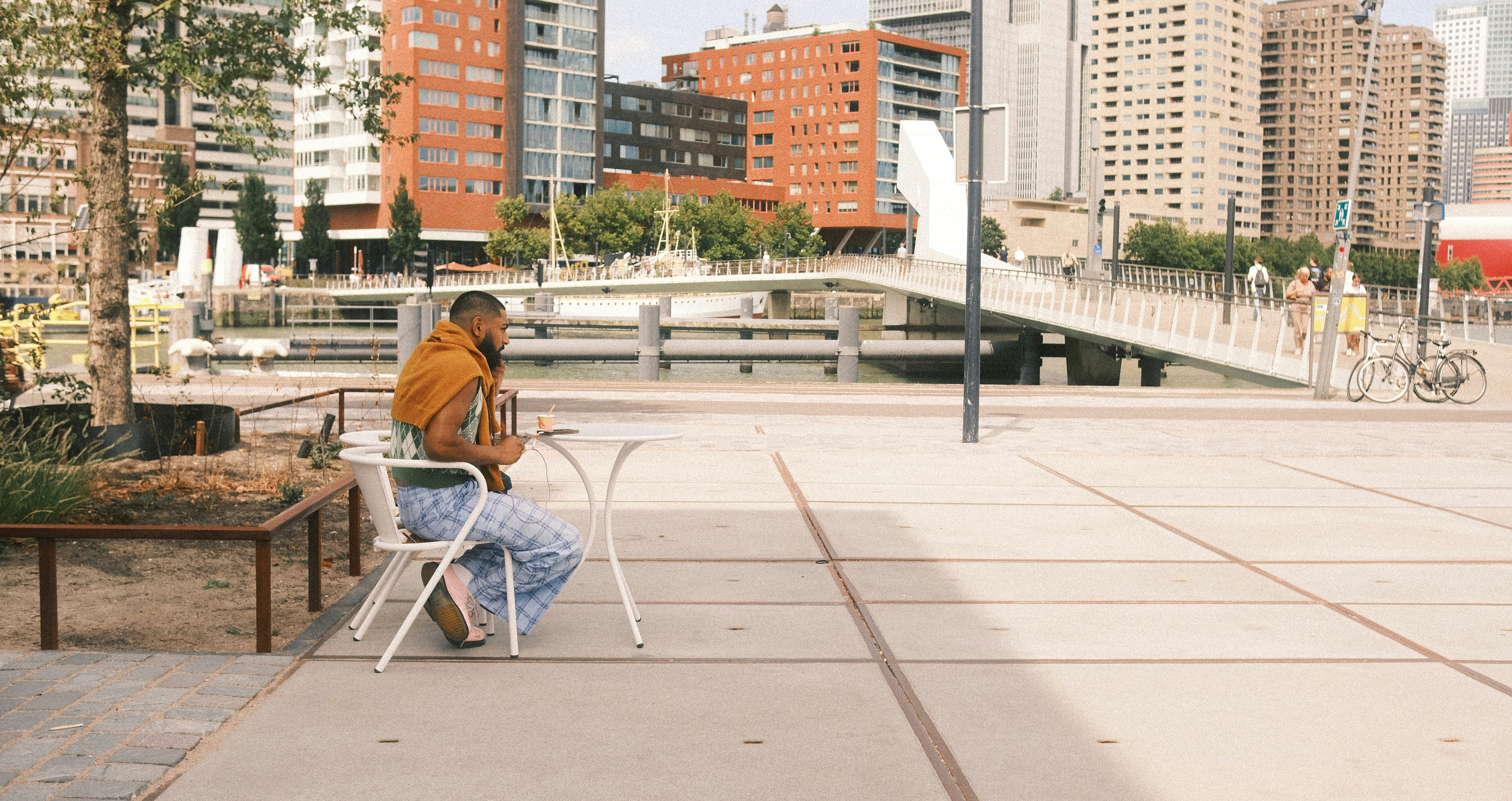 Quiet Balcony Moment: A Monk-like Pause in the Urban Harbor