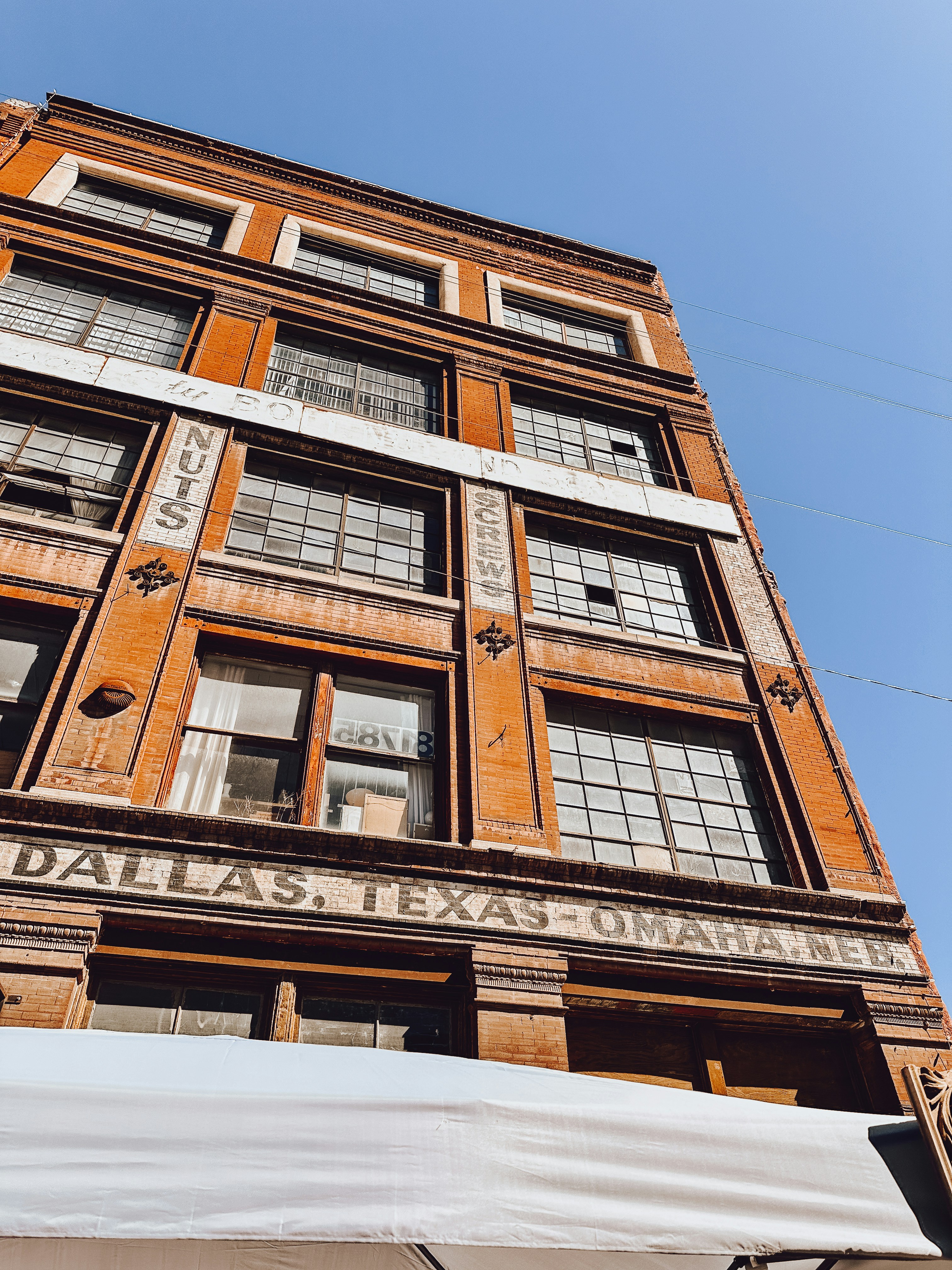Brick Facade of Dallas, Texas – A Tall Upright View Under a Clear Sky