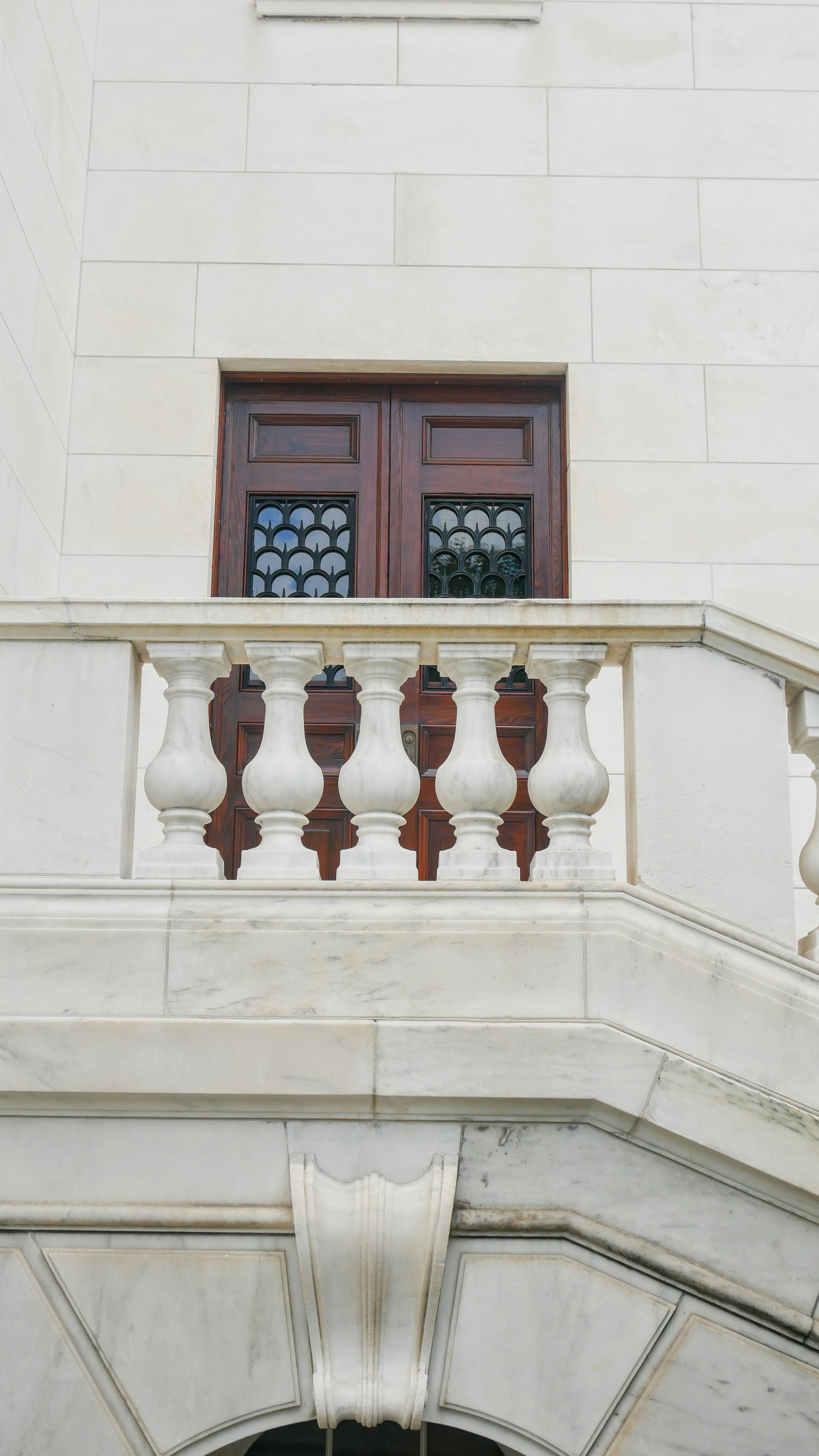 Balustrade Balcony and Wooden Window Set in Marble Facade