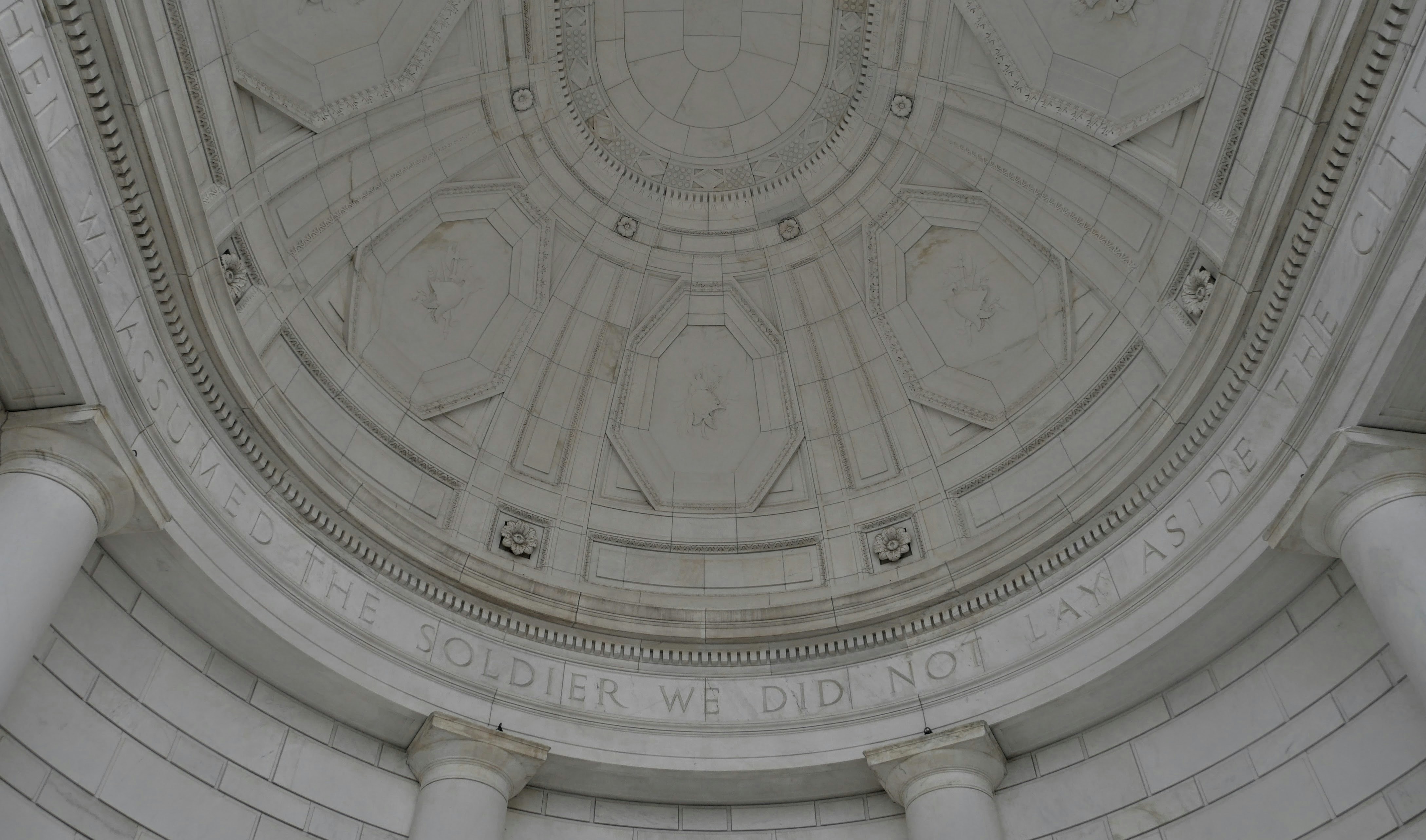 Intricate marble dome with columns and carved inscription