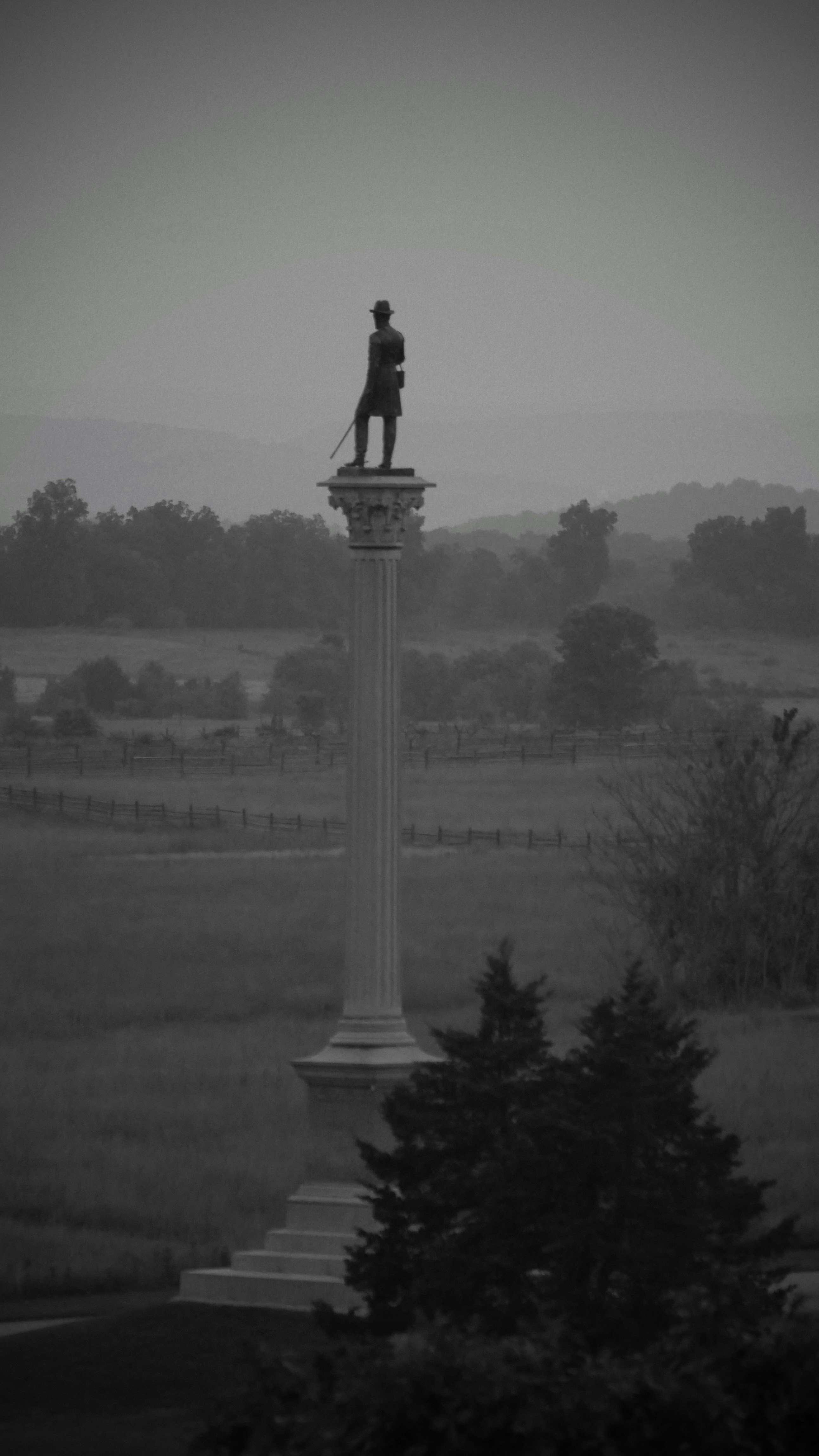 Column of Silence: A Lone Statue Reaches Toward a Misty Horizon