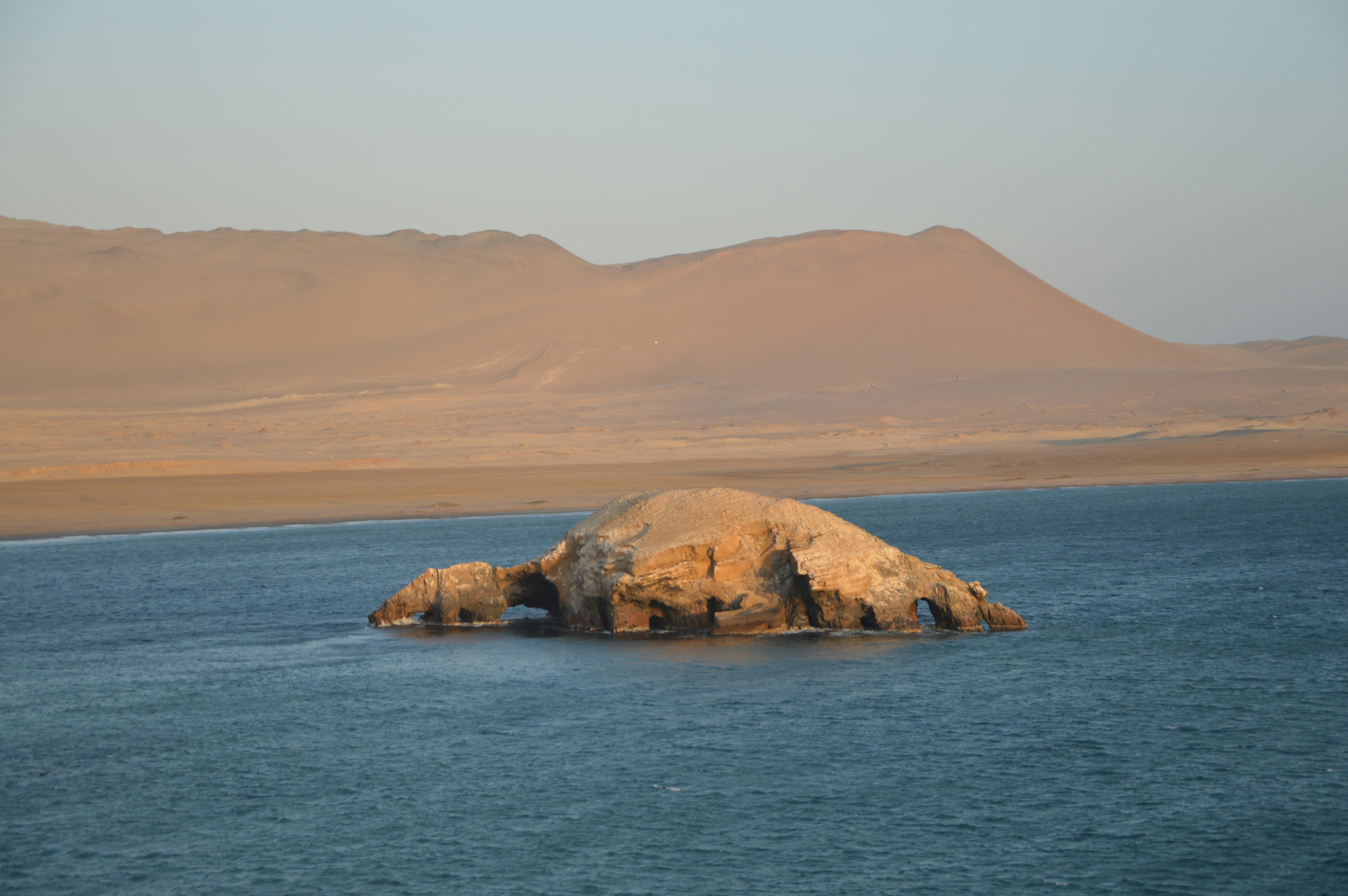 Desert Islet Rising from Quiet Coastal Waters