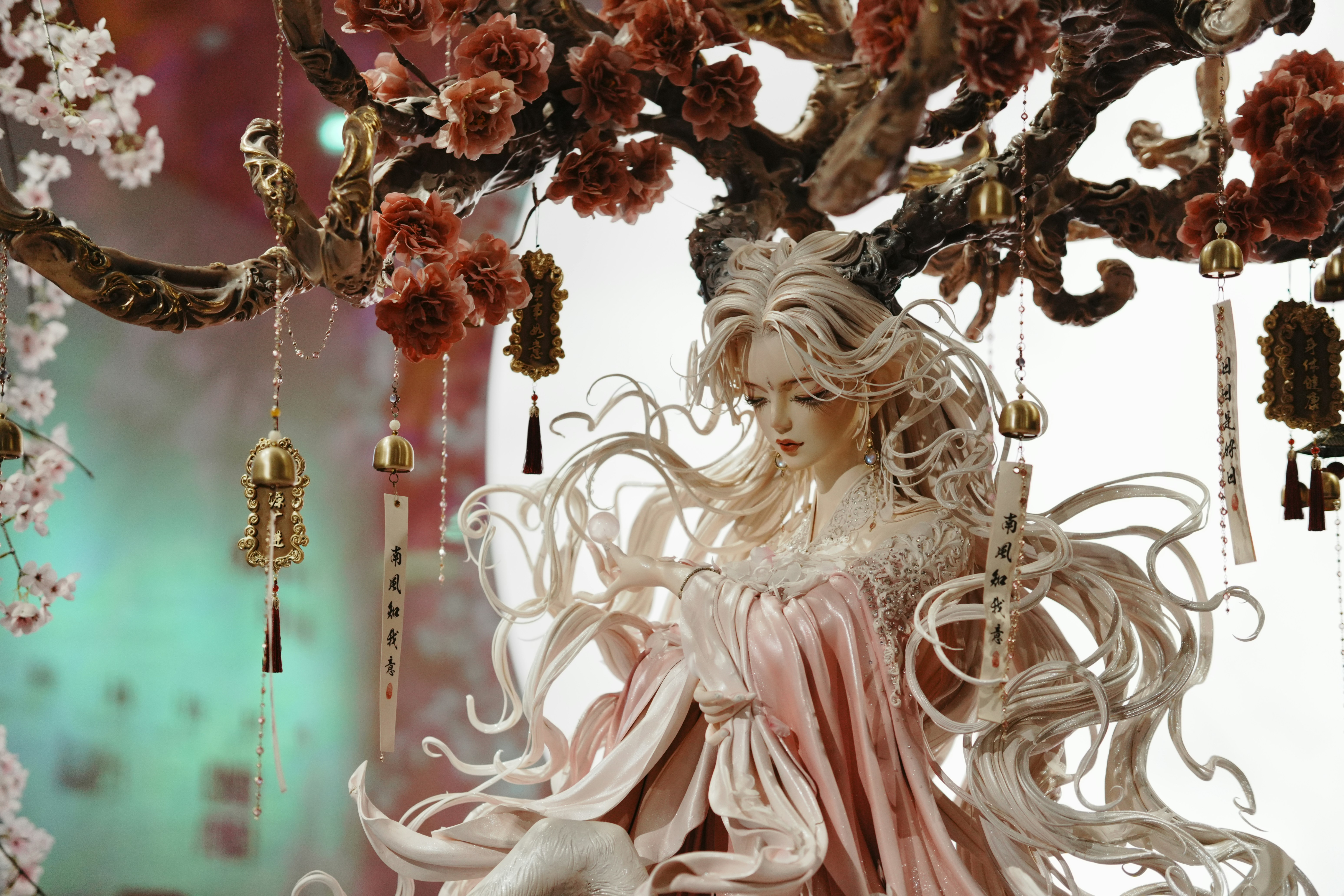 Pink-gowned figure beneath blossoming branches