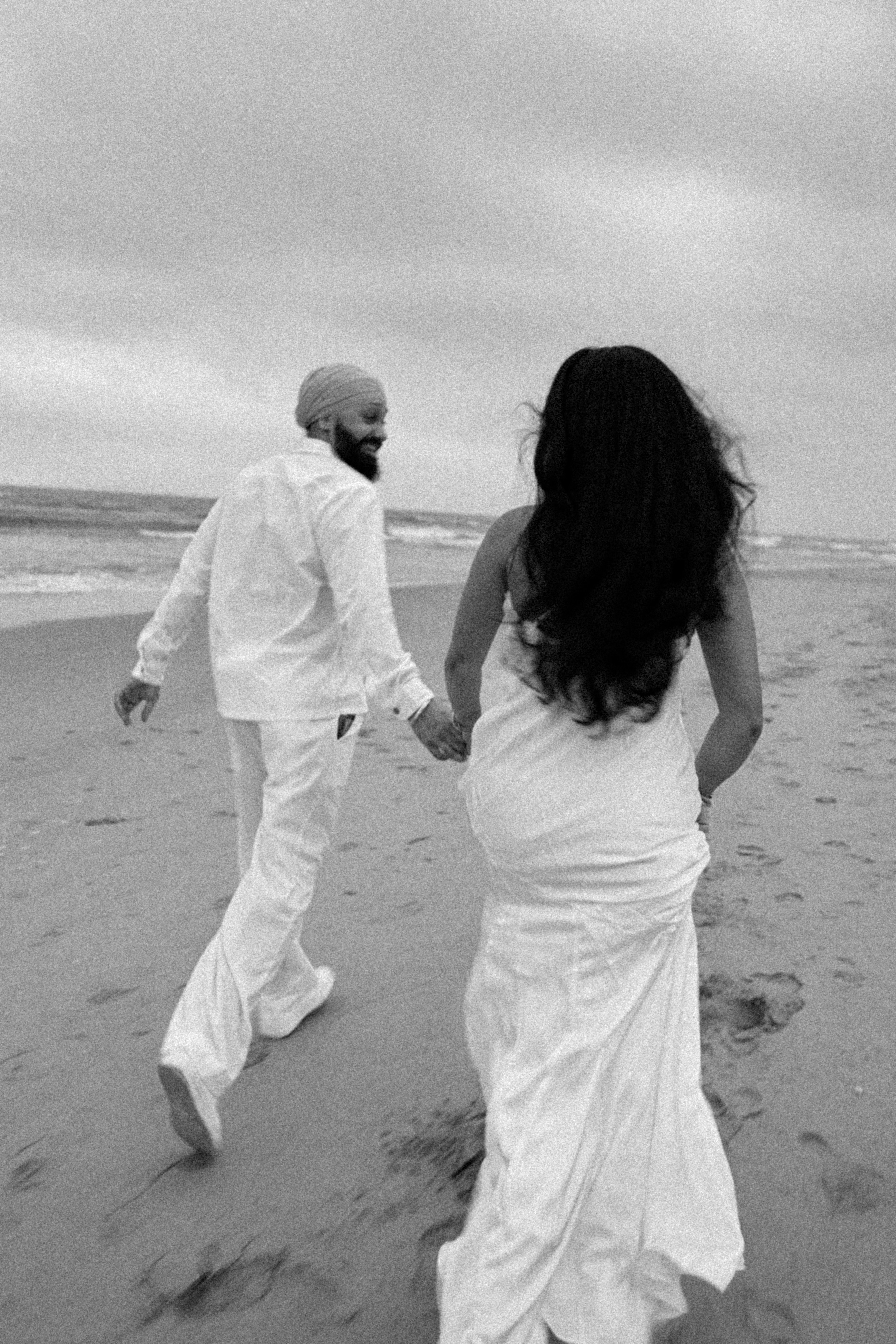Walking Away Together: A Bride and Groom on a Windy Beach