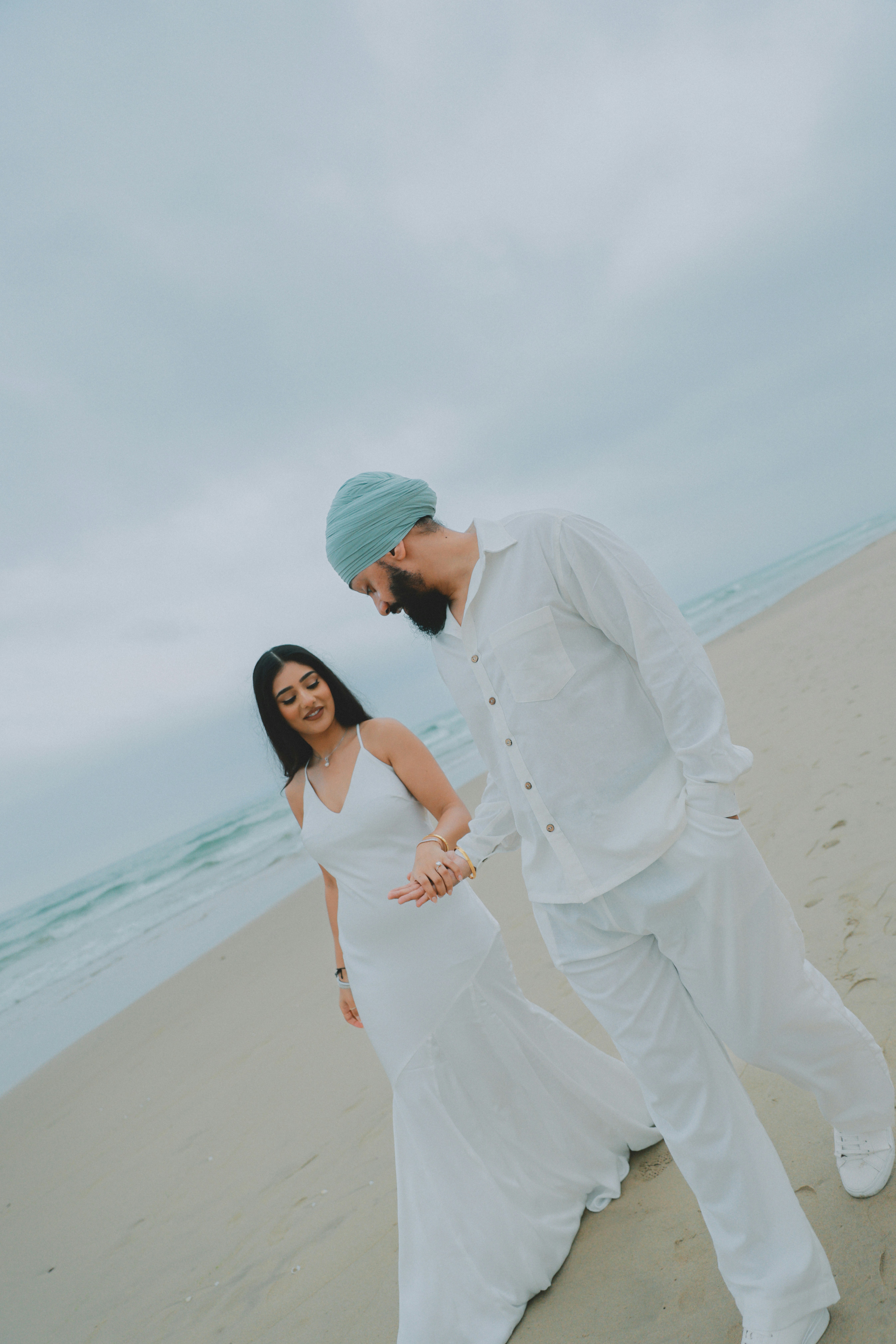 White-veil vows on a sunlit shoreline