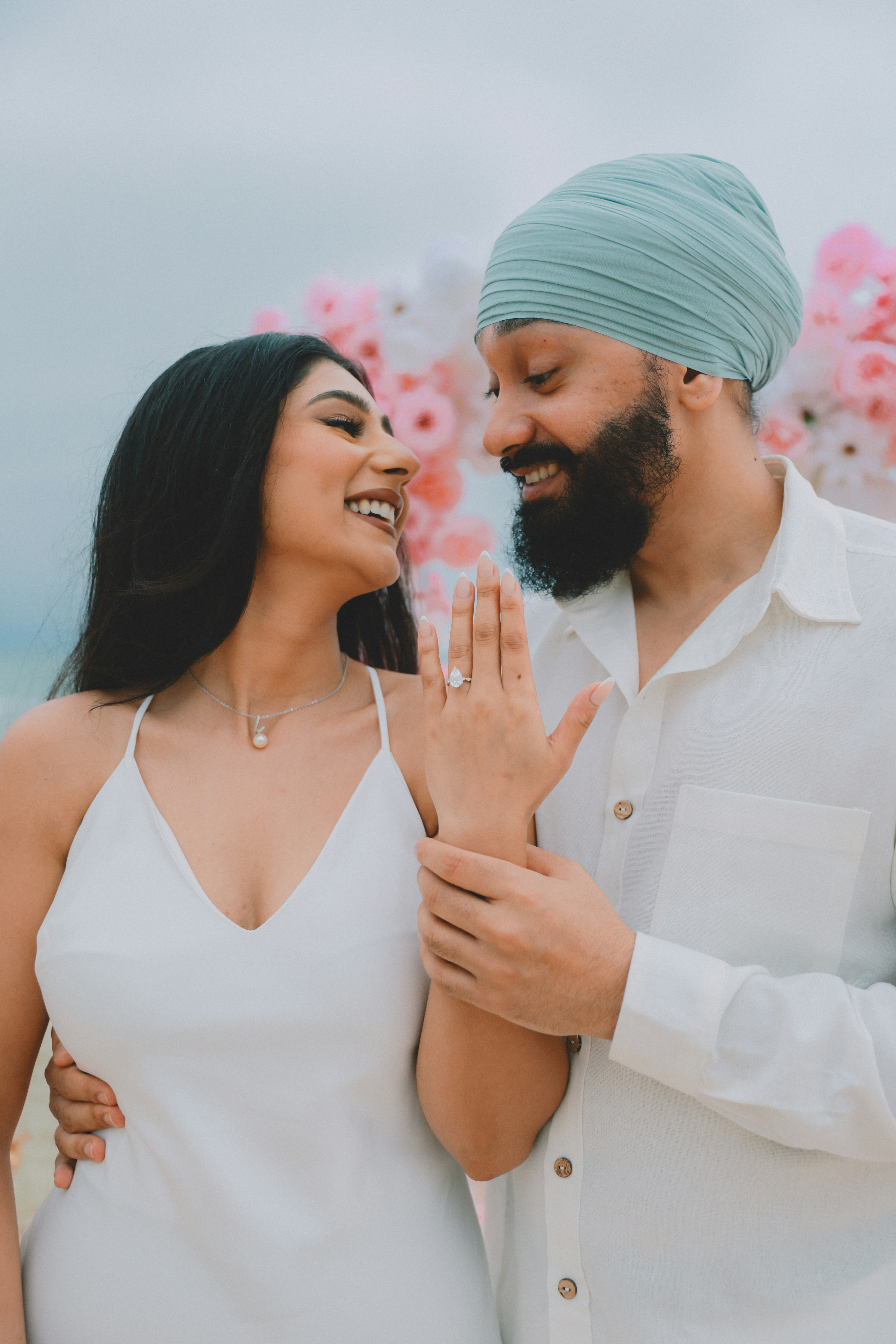Two rings, one promise: a candid exchange under soft seaside light