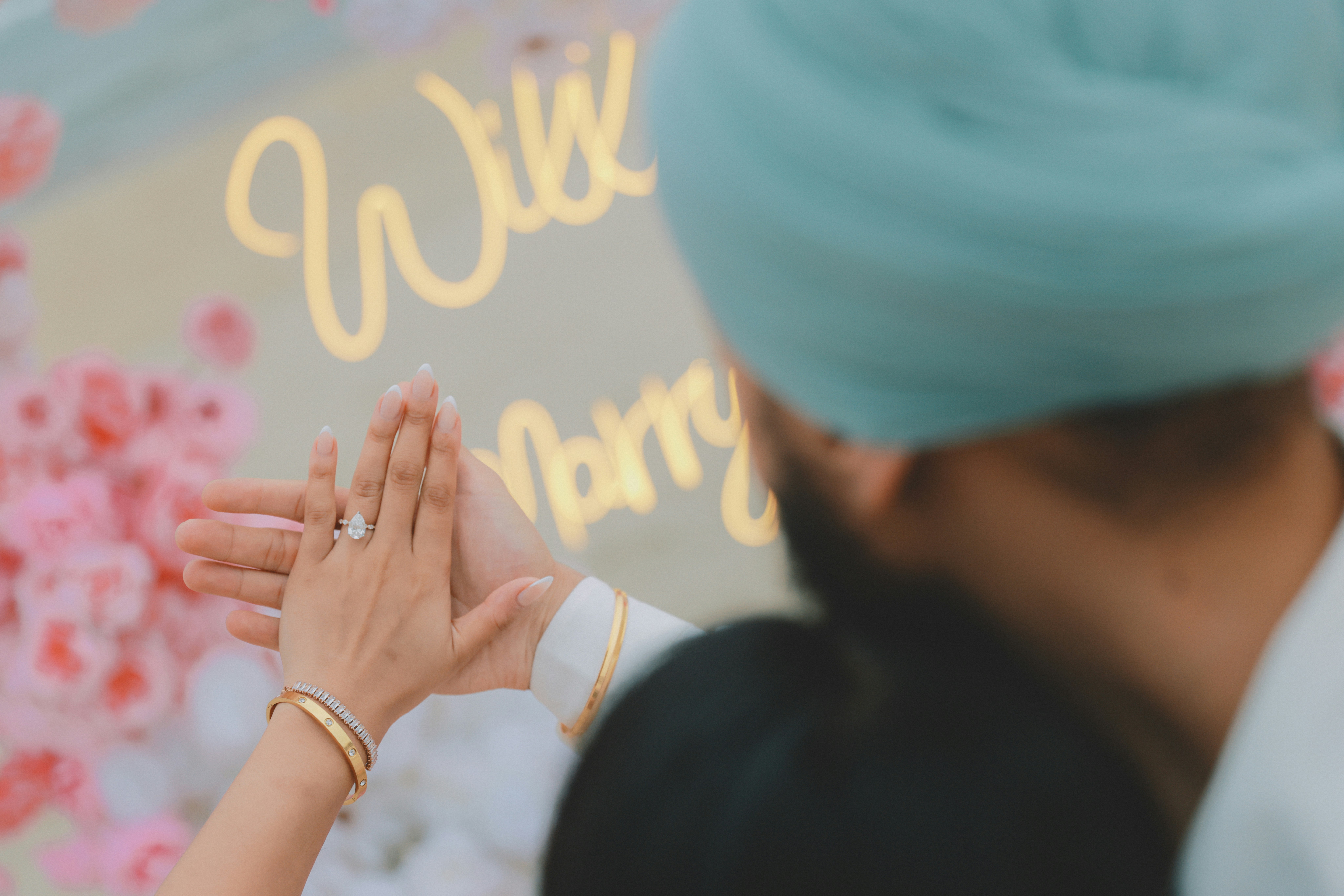 Hands Together: A Moment of Union at a Wedding Backdrop