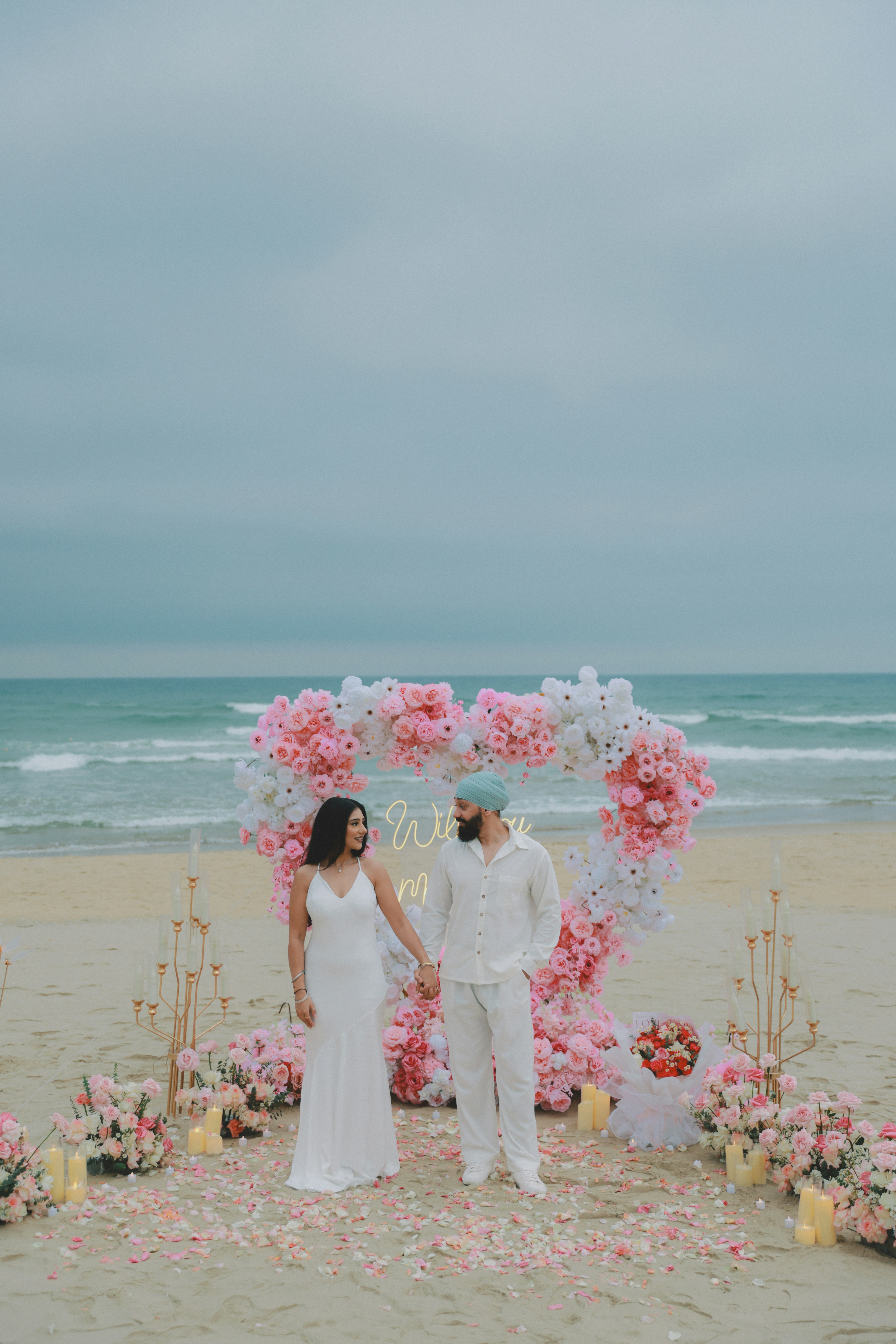 Seafront vows beneath a Petal Arch