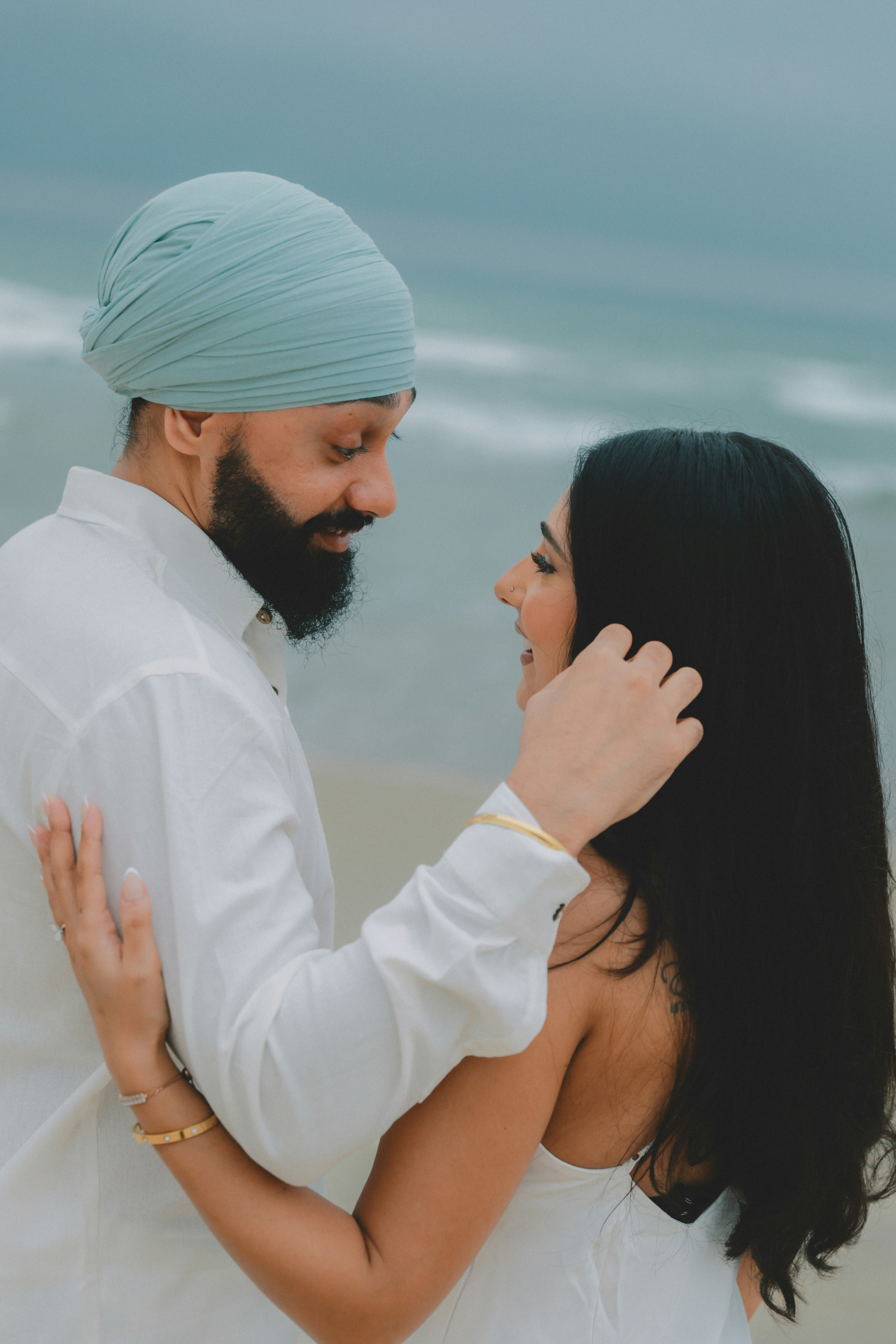 Close embrace at the shoreline: a moment of quiet connection