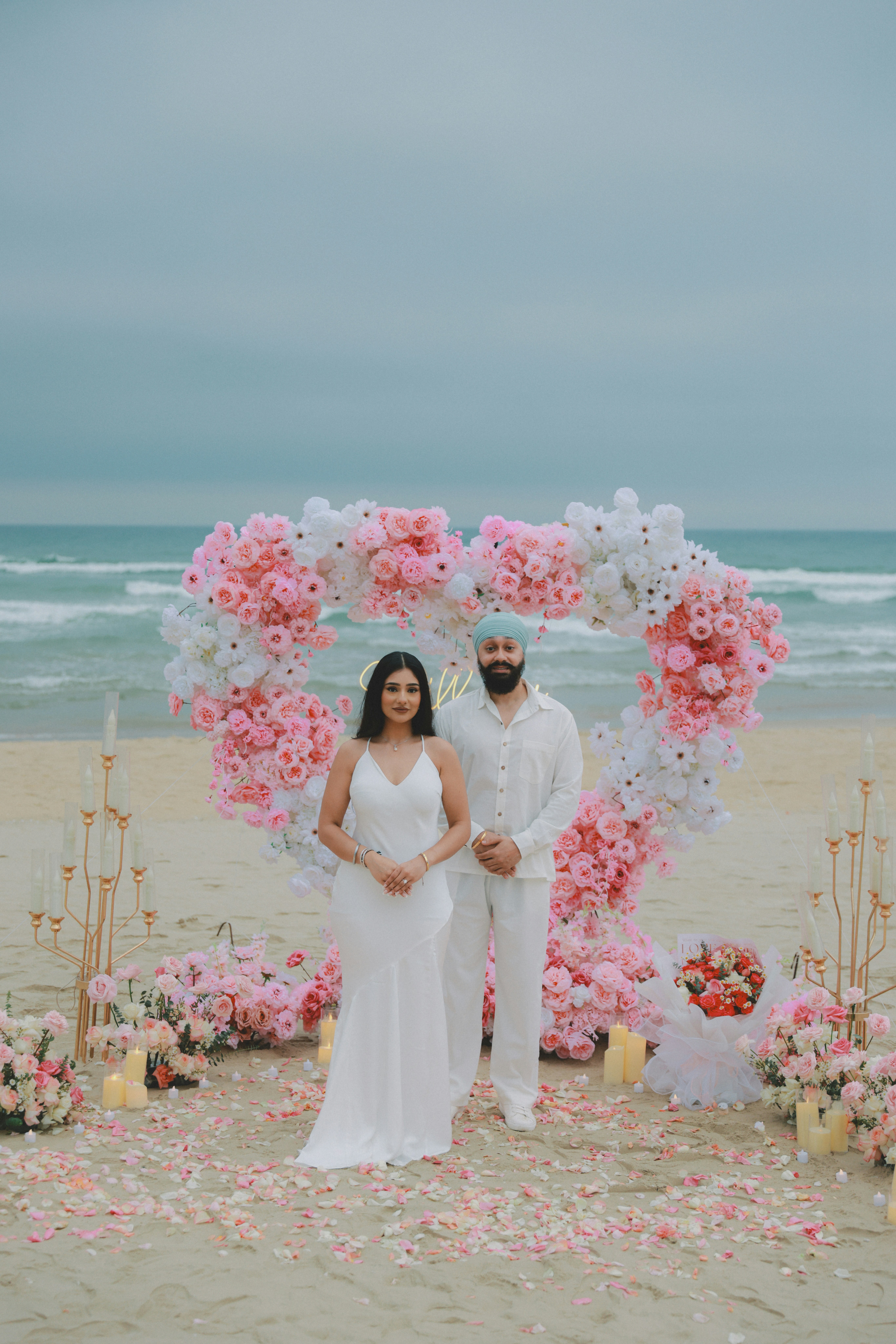 Ceremonial Moment Under a Petal Heart on the Shore