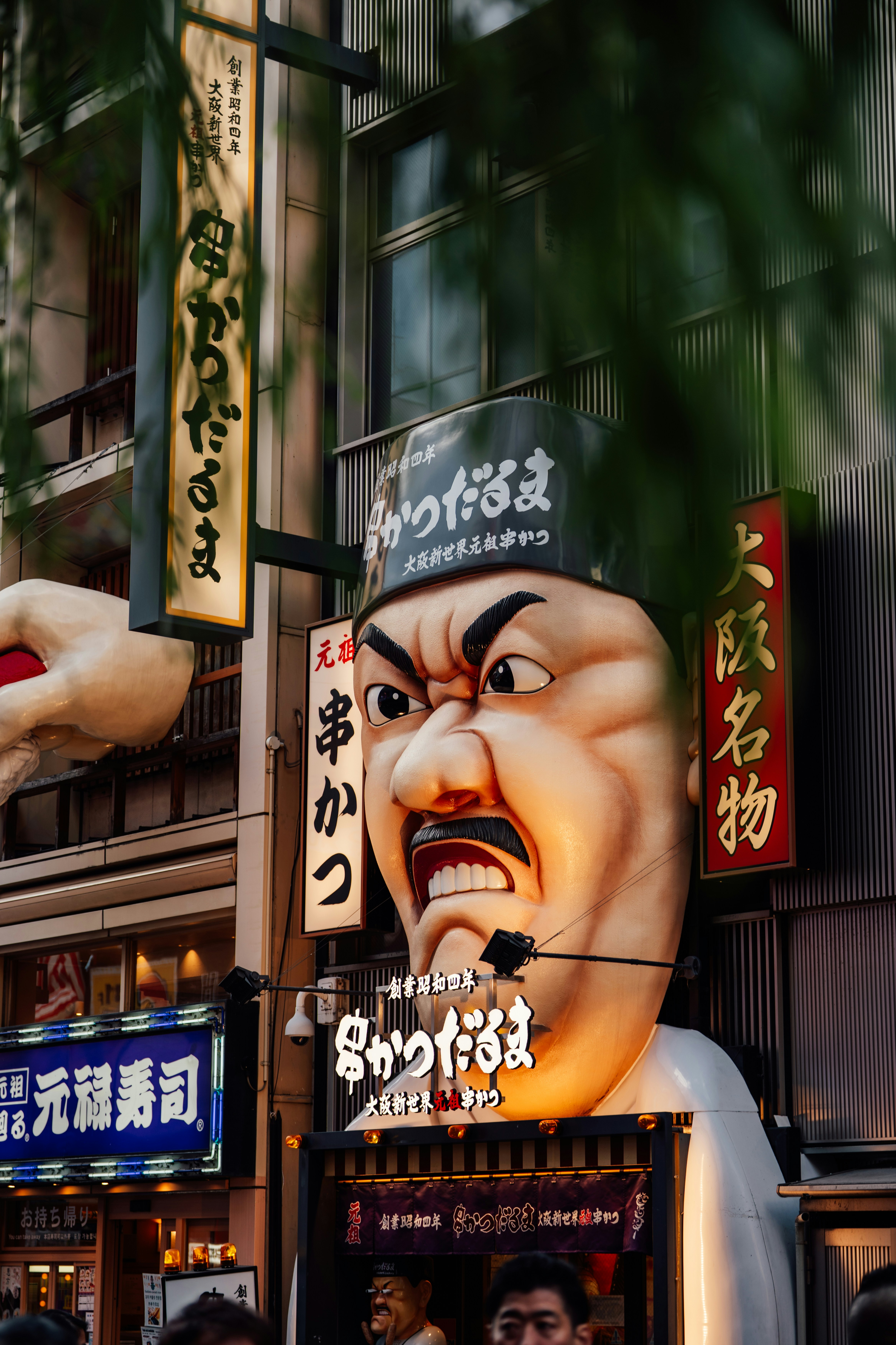 Gigantic Chef Mask Faces Off Over Noodles in Dotonbori