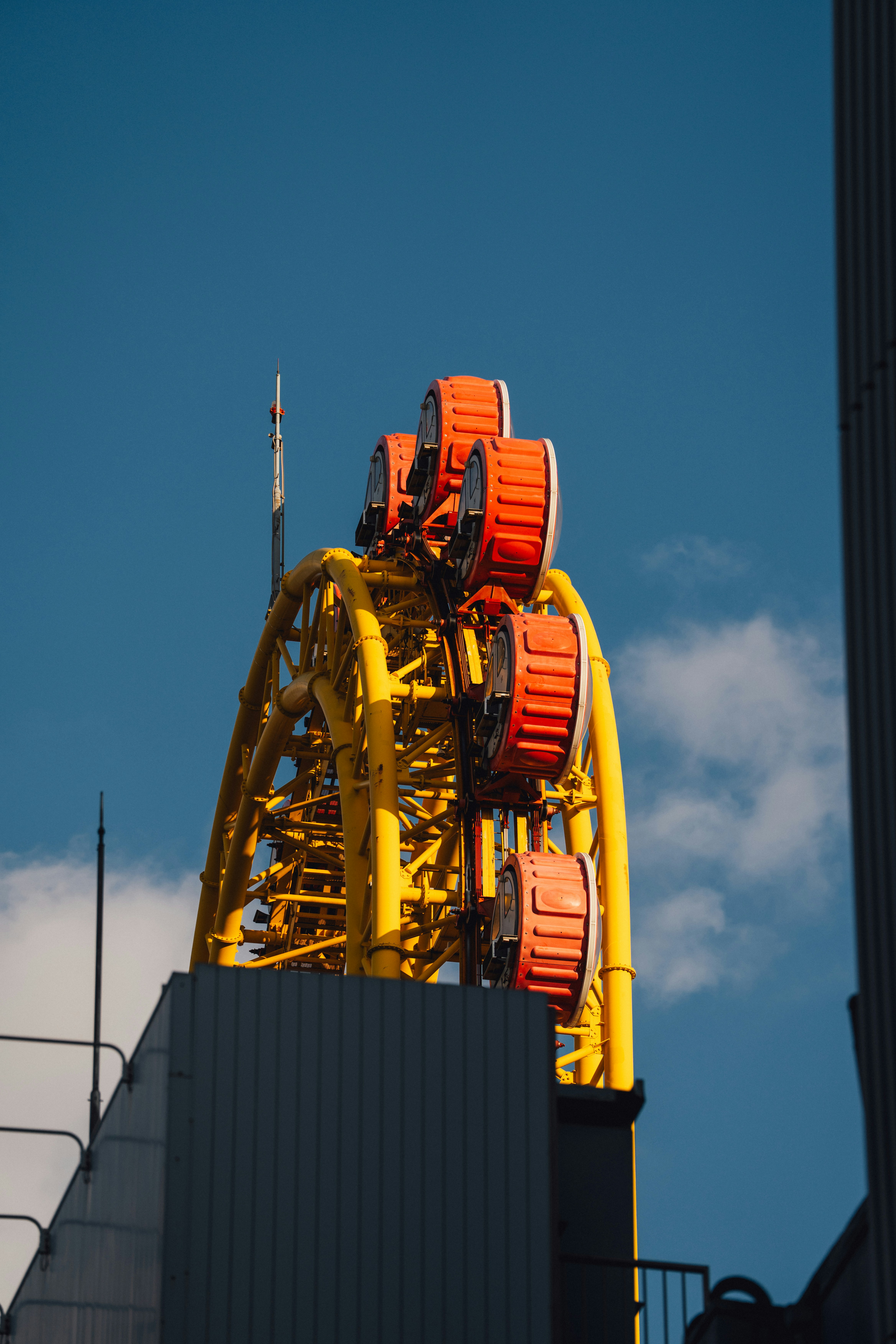 Yellow Ferris Wheel Arc Ascends Against a Clean Sky