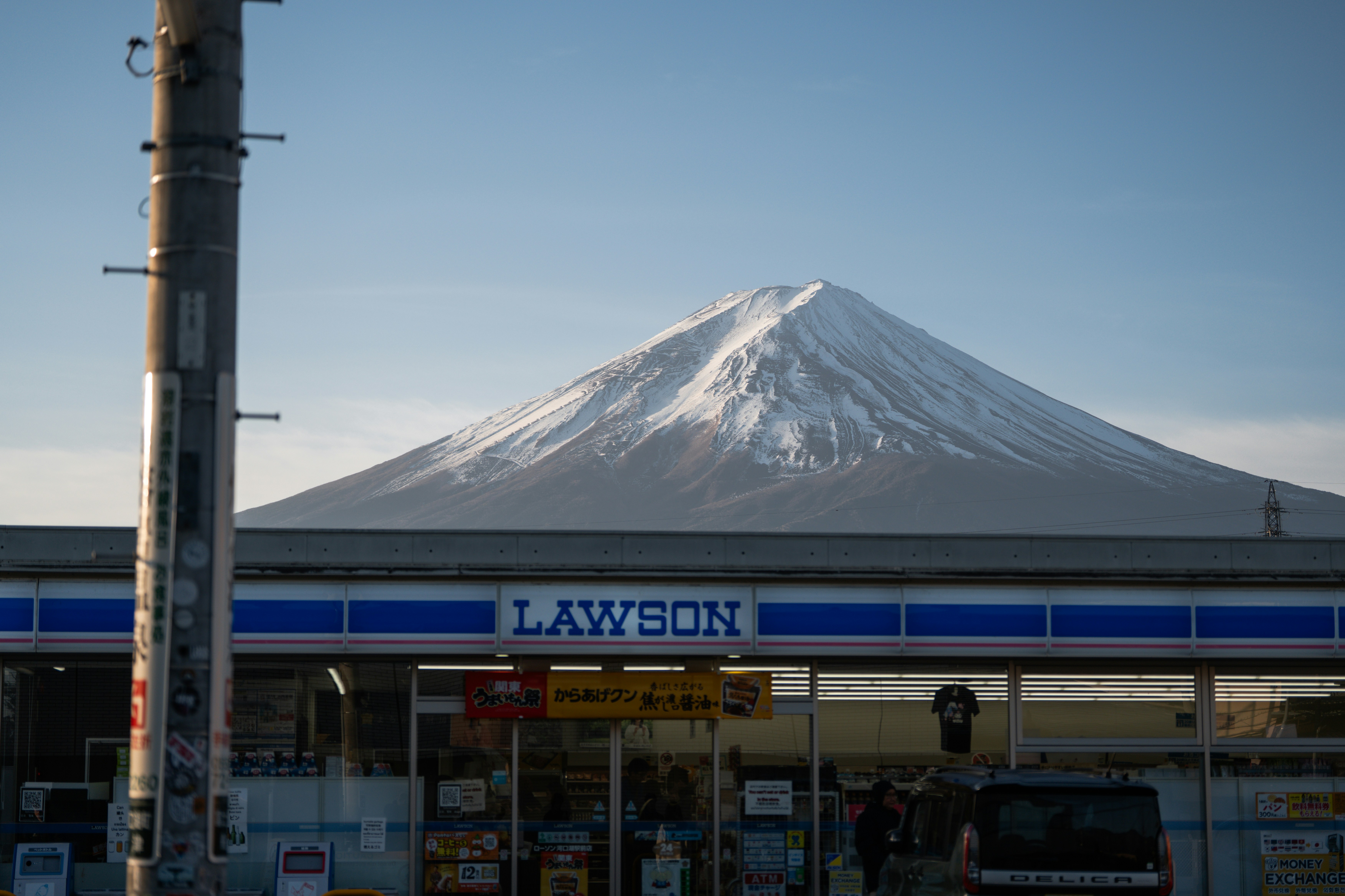 Snow-Capped Peak Over a Quiet Convenience Store Front