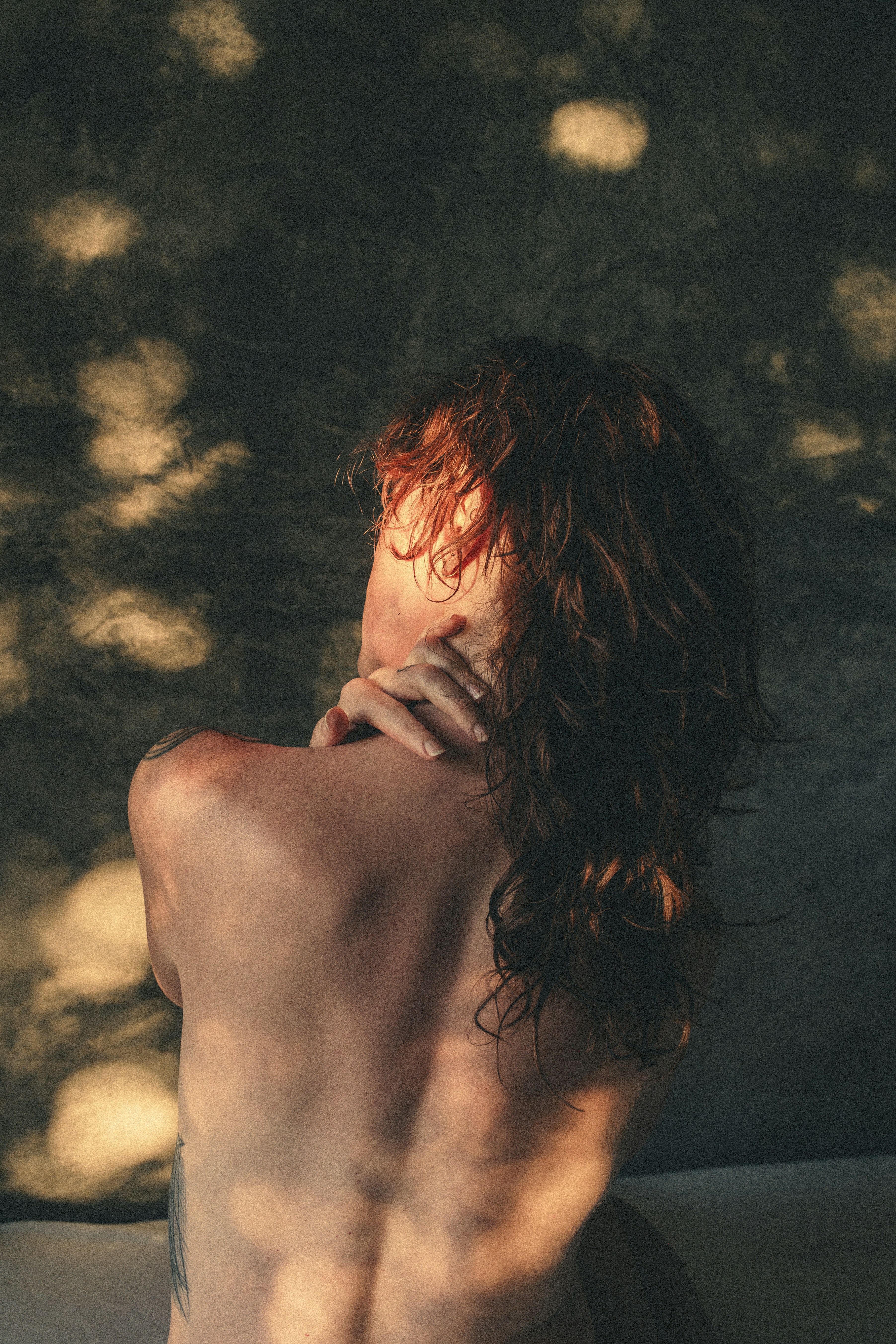 Woman with red hair bathed in warm sunlight