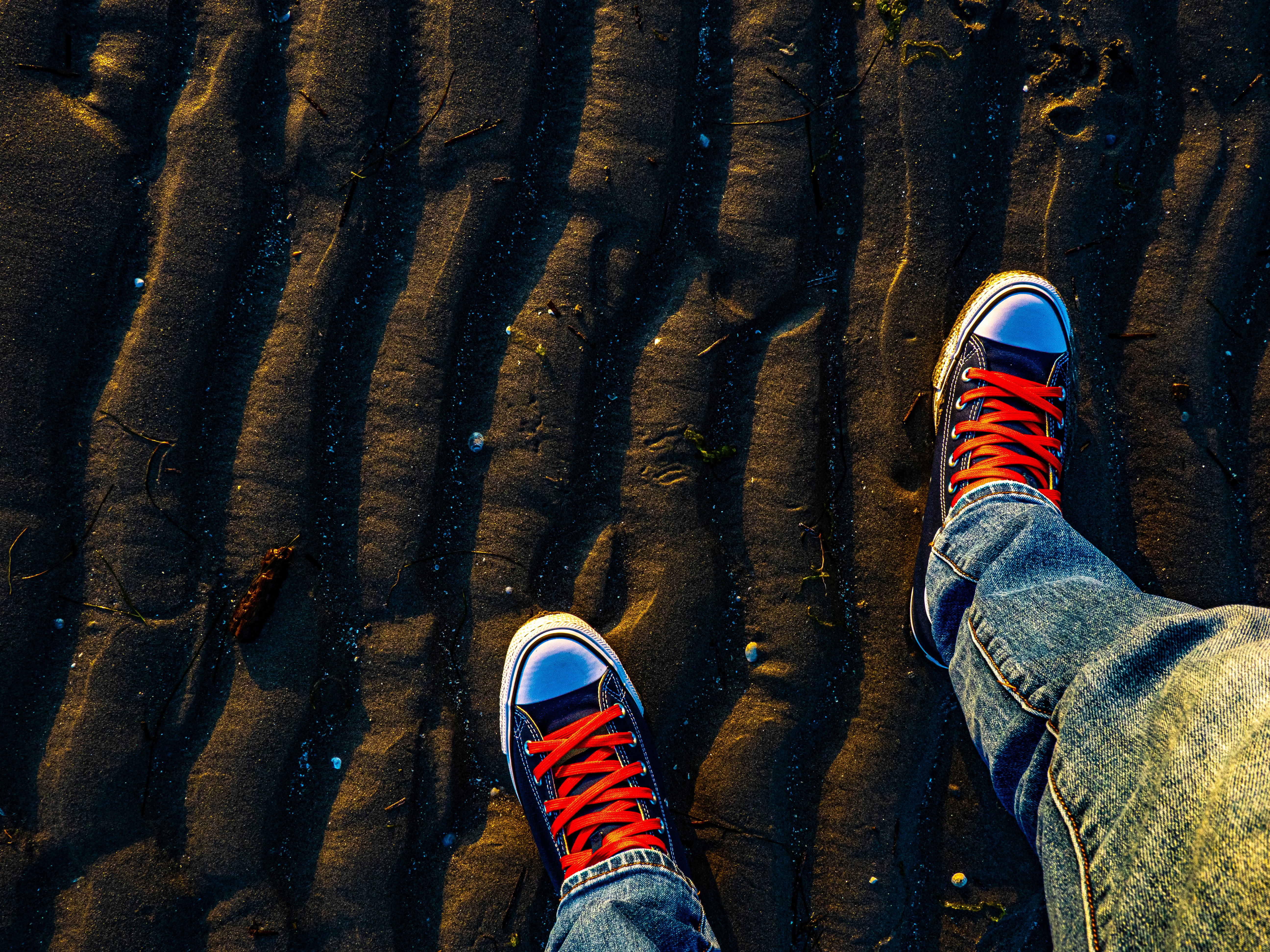 Stride Through Rippled Sand: Colorful Sneakers on a Golden Shore