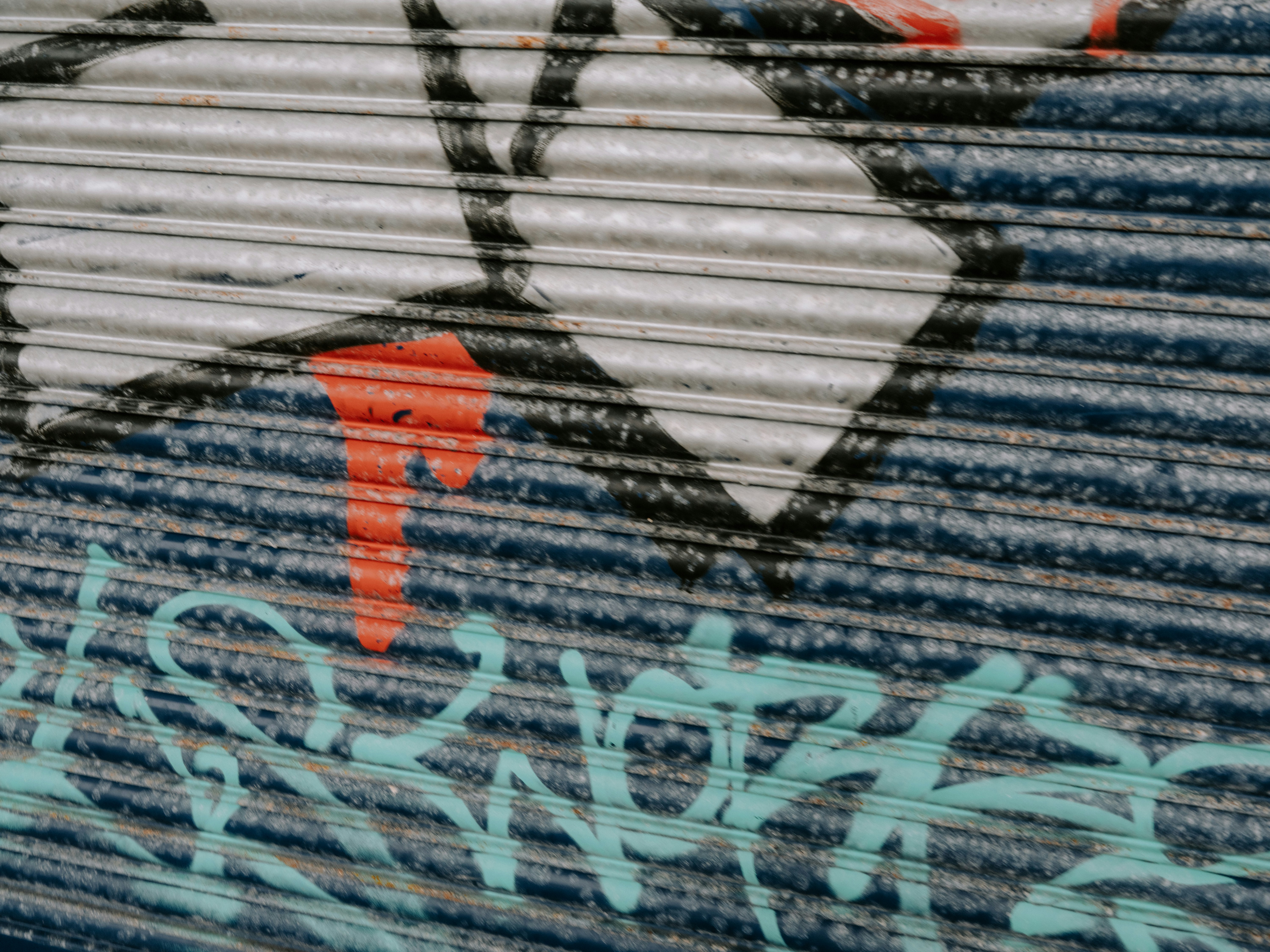 Urban Echoes: Colorful Rhythm on a Graffitied Metal Roll