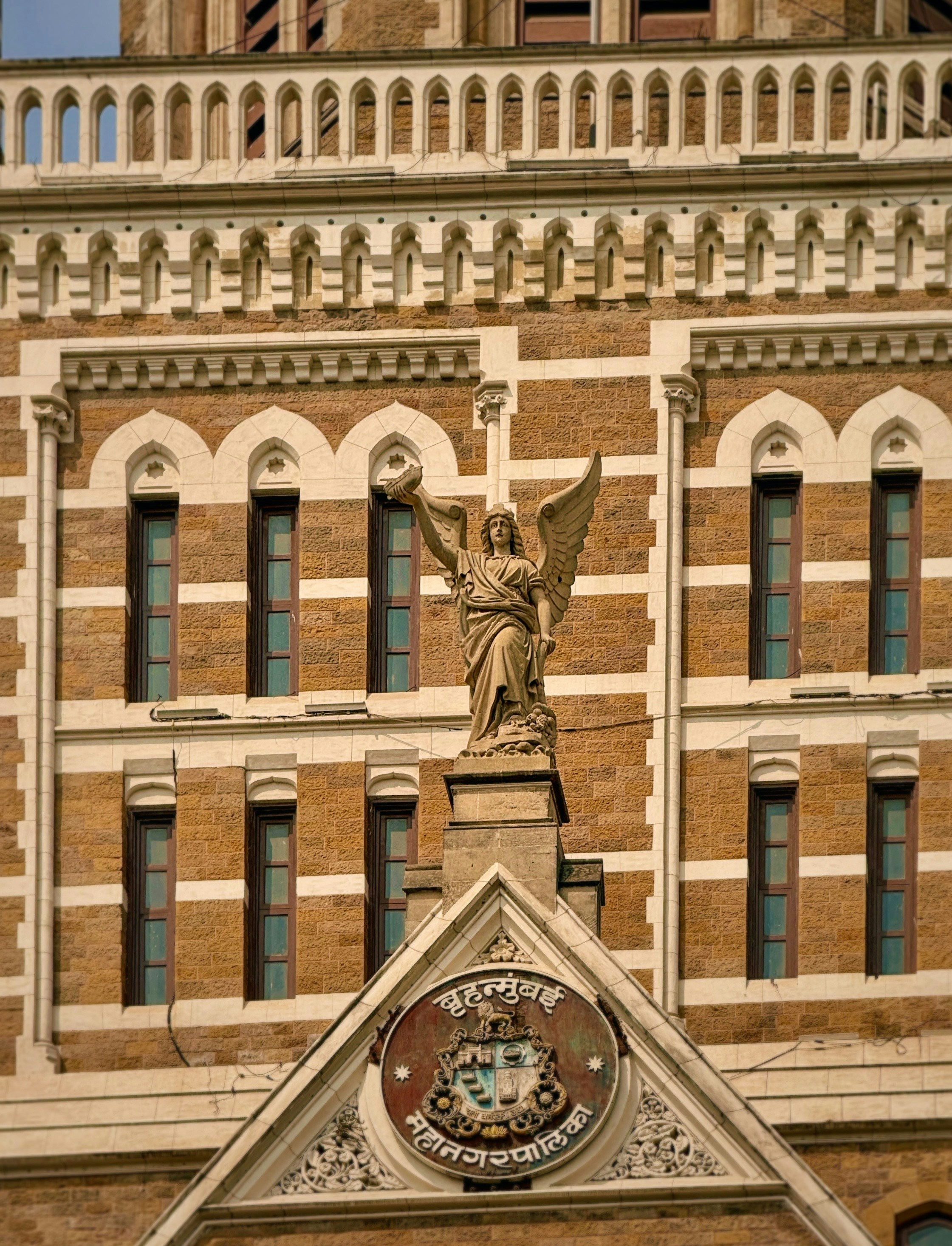 Winged Statue Over A Historic Facade