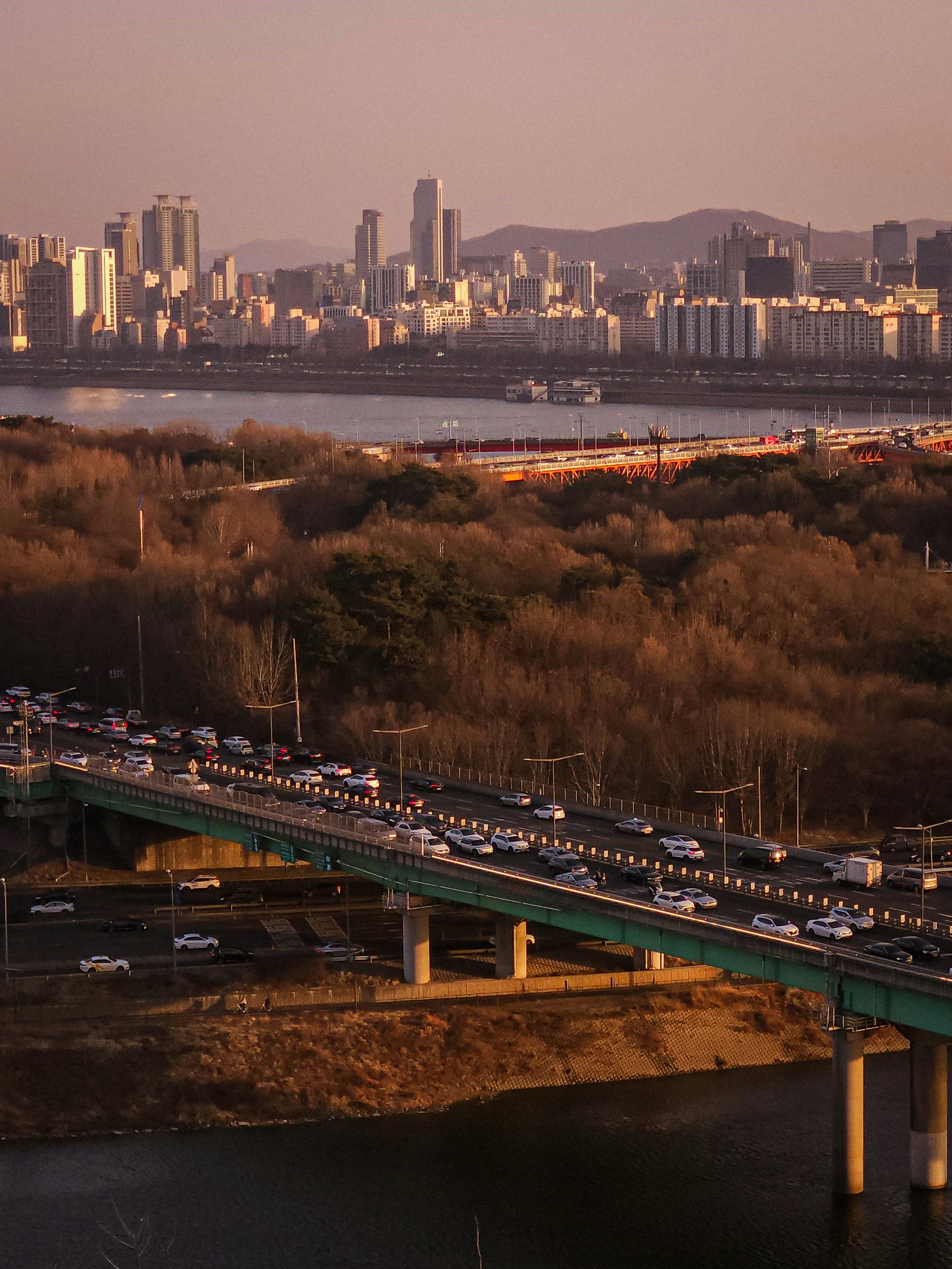 City Pulse Over the River: Bridges, Cars, and Dusk Light