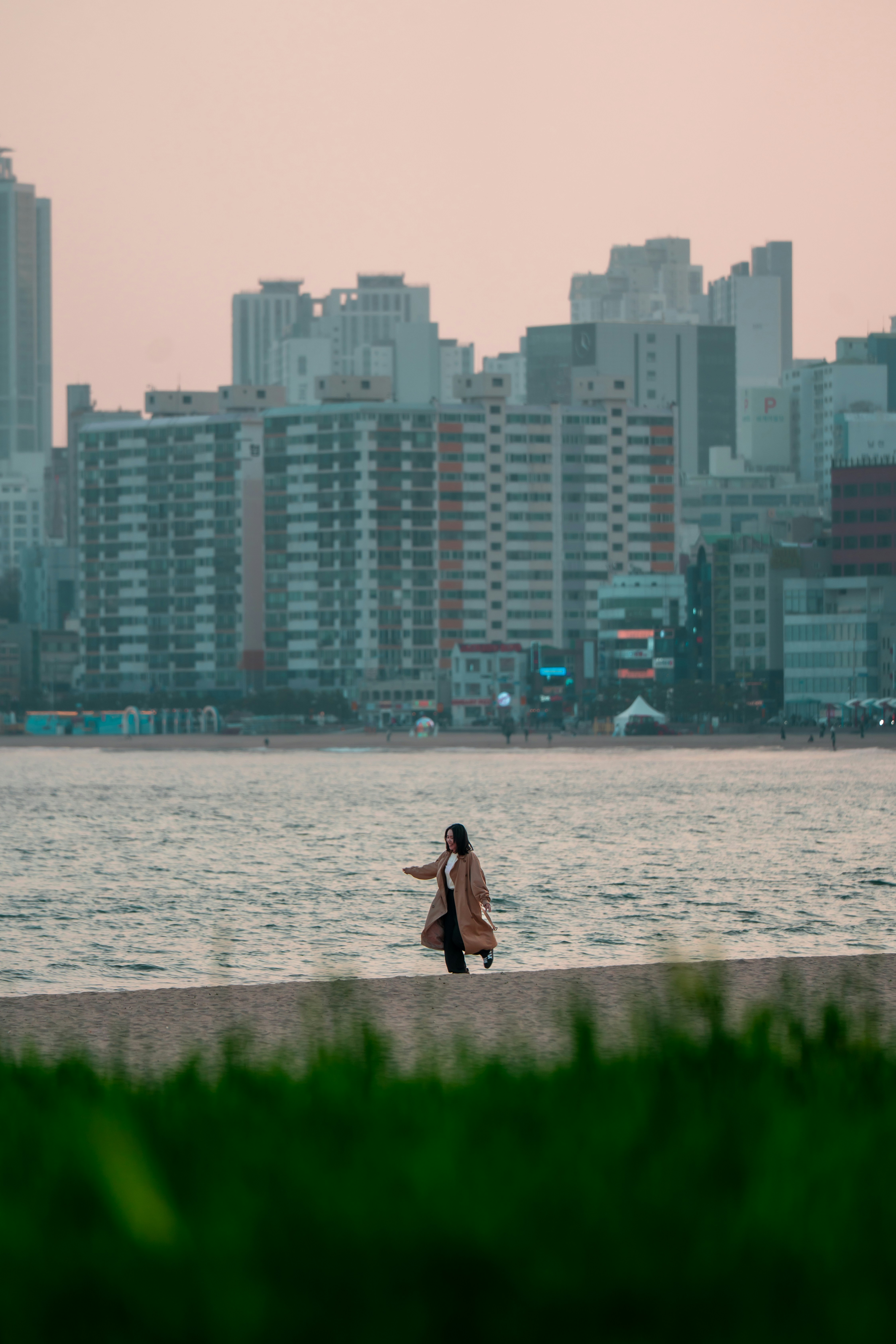 Coastal Walk: A Lone Figure Against a Skyline of Waves