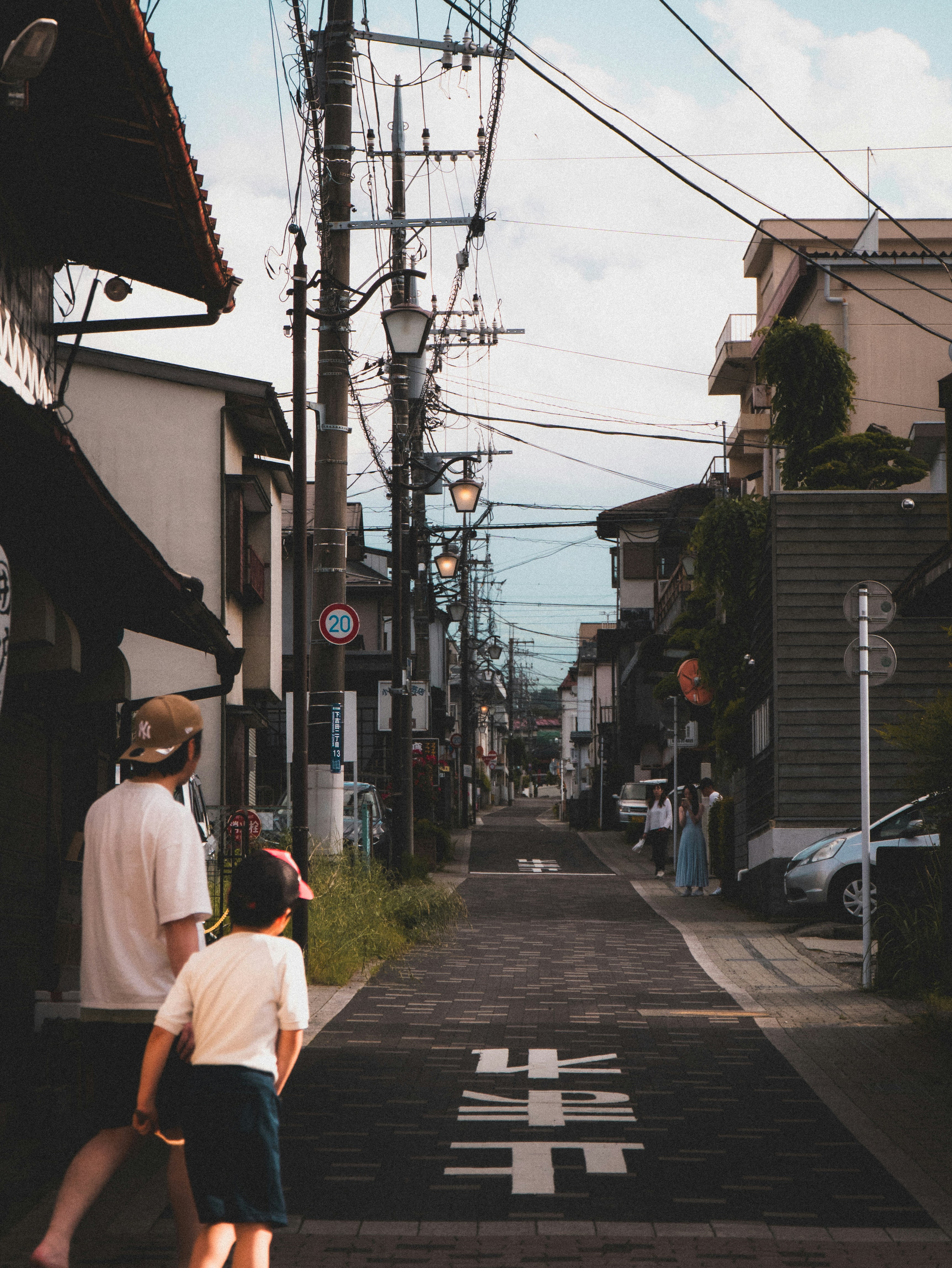 Two Figures at the Edge of a Quiet Japanese Alley
