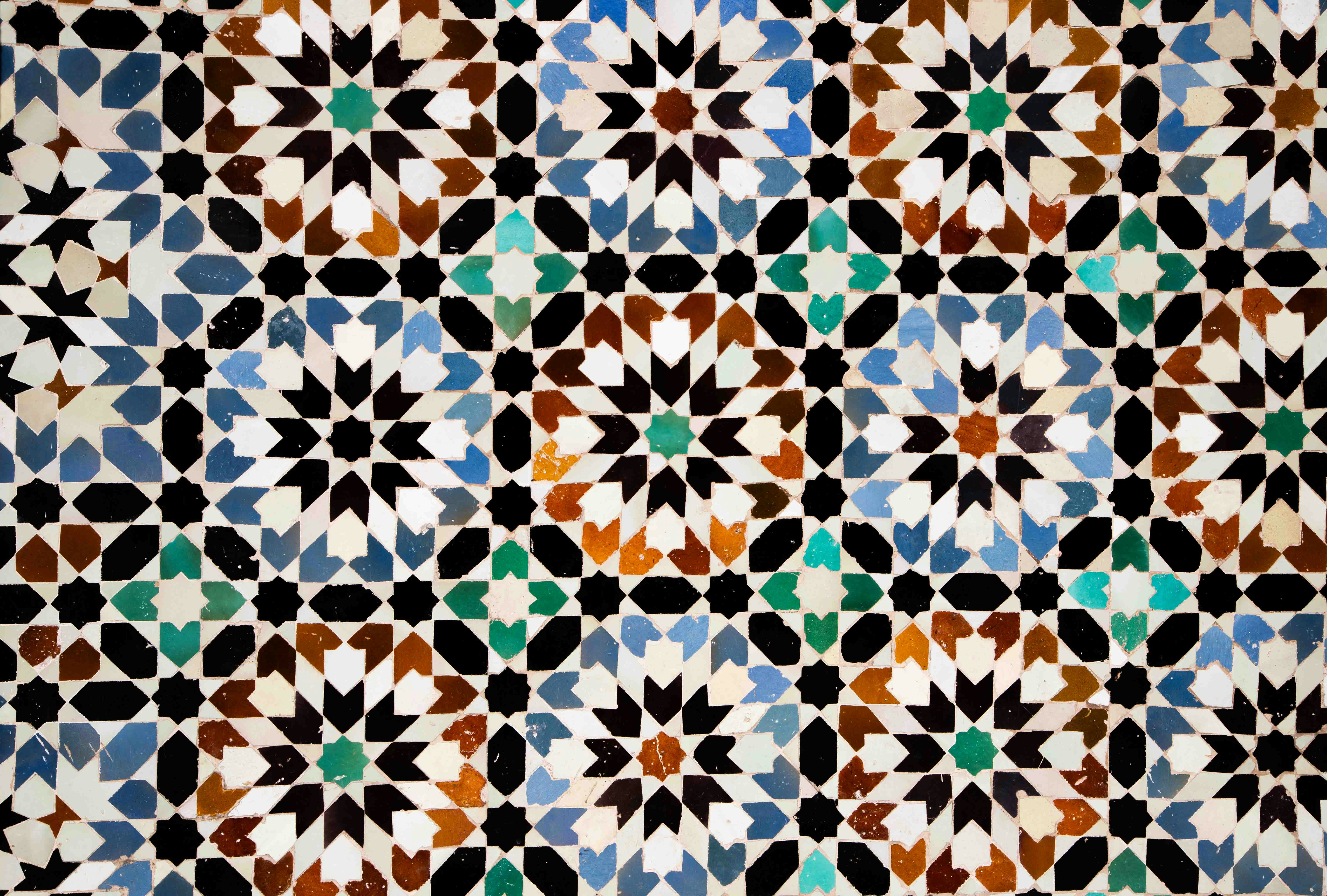 Intricate geometric tile pattern with blue, orange, and green accents.