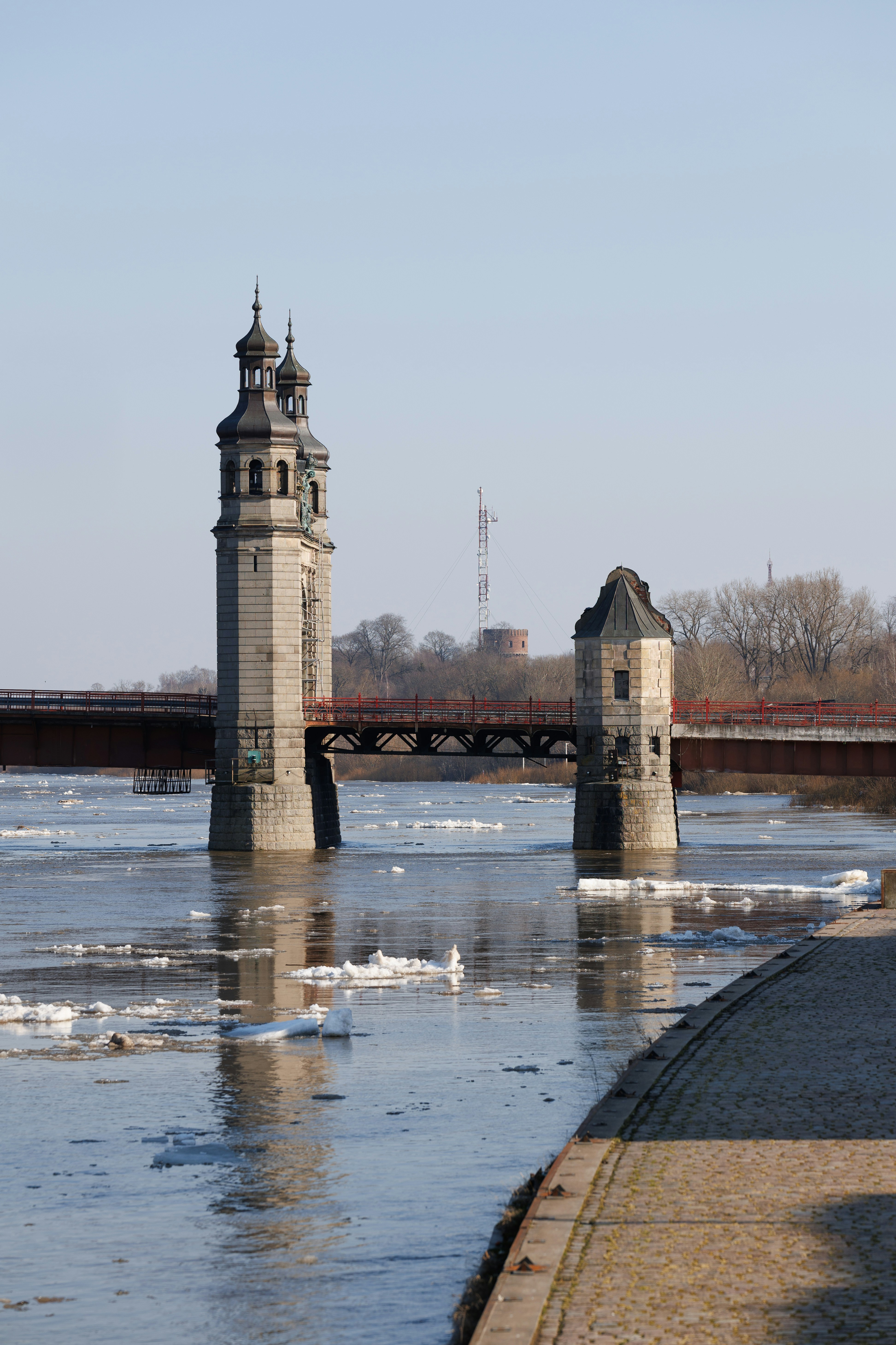 Bridge Towers Rising from Icy Riverbank