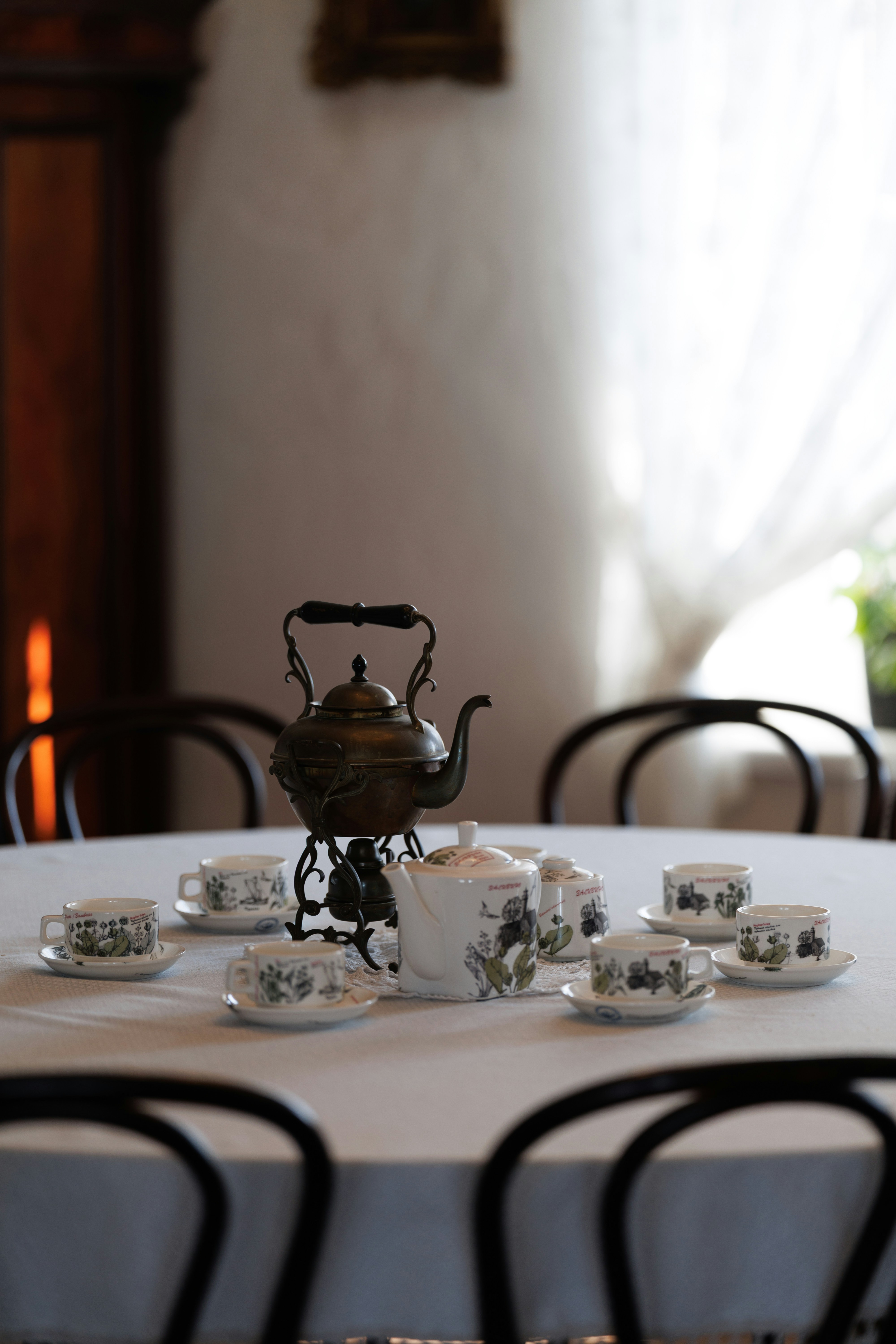 Heritage Tea Service: A brass kettle centered among porcelain cups