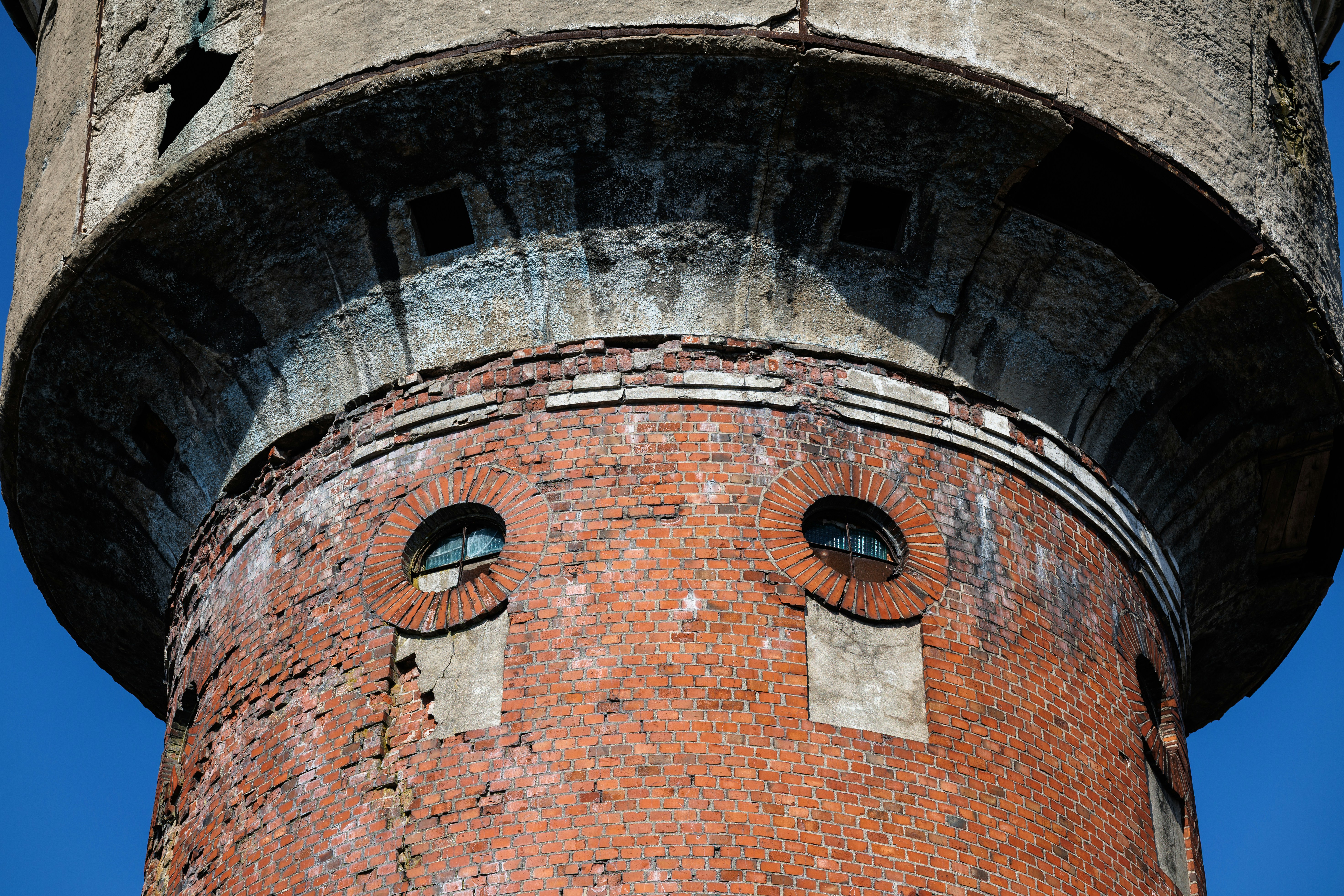 Brick Tower in Blue Sky: A Weathered Circular Keep Rising Above the Horizon