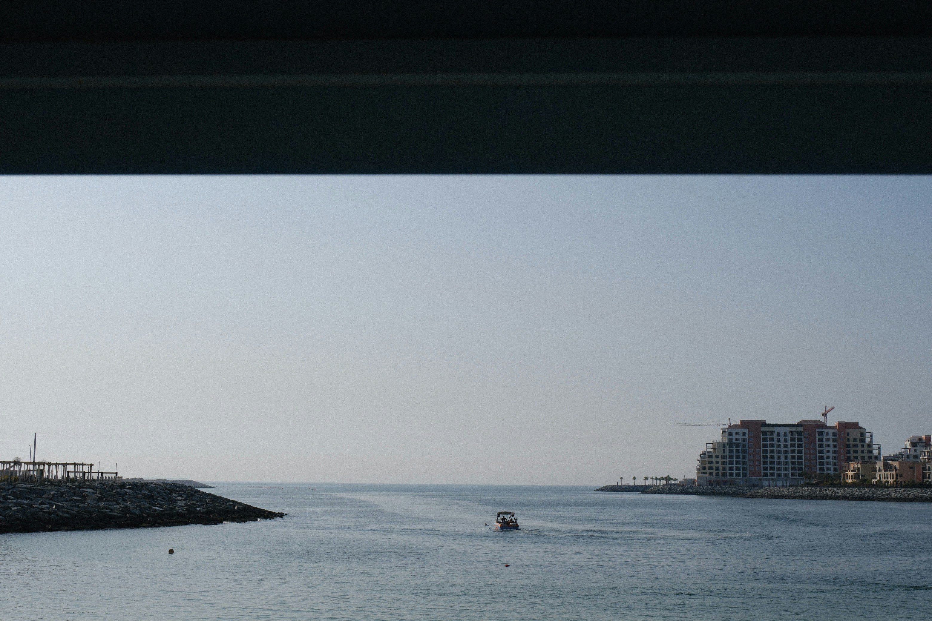  Coastal Passage: Boat Between Shorelines on a Calm Day 