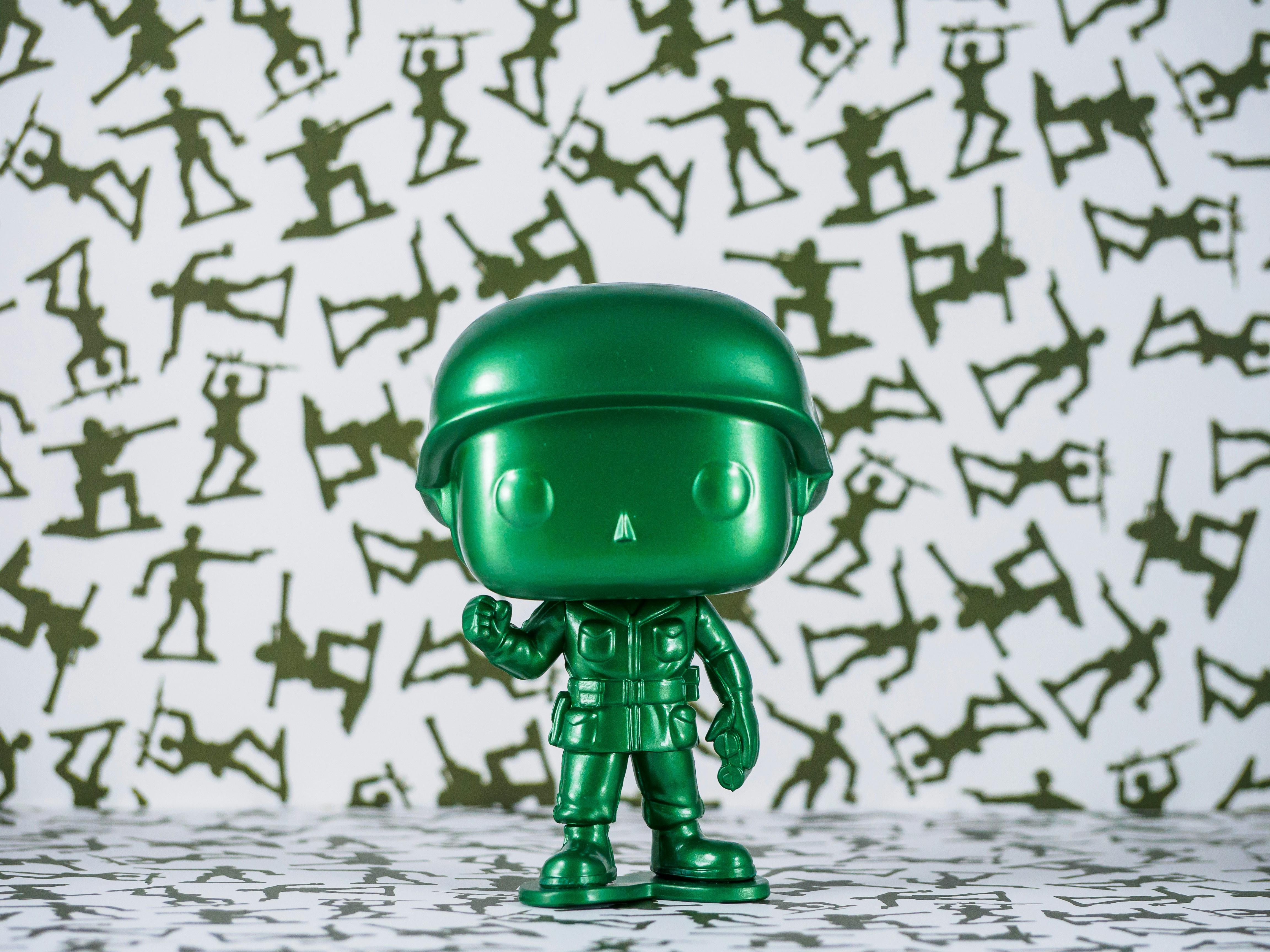 Emerald Sentinel: A Green Funko Stands Bold Against Repeating Silhouettes
