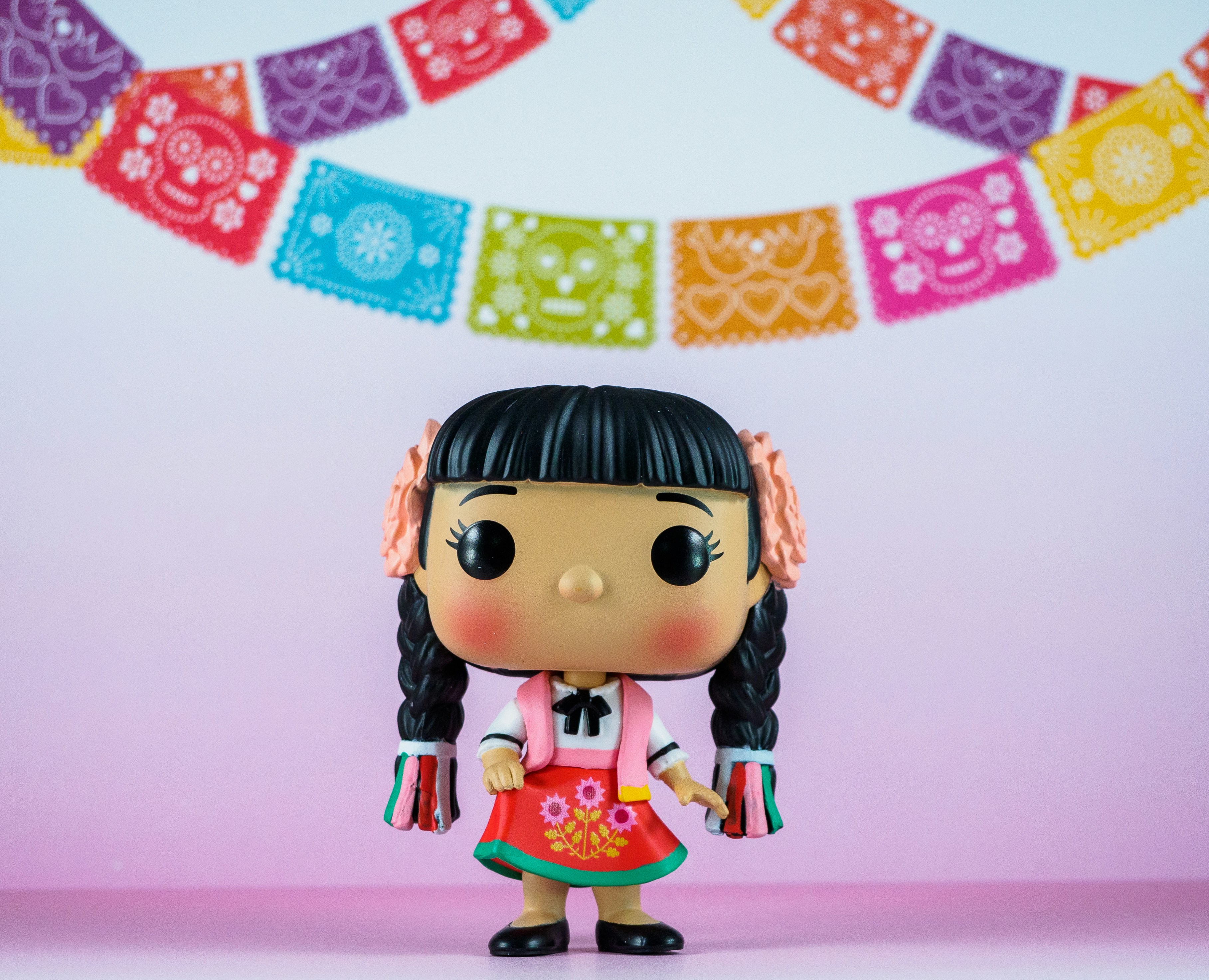 Whimsical Frida-inspired Doll Under Festive Banner