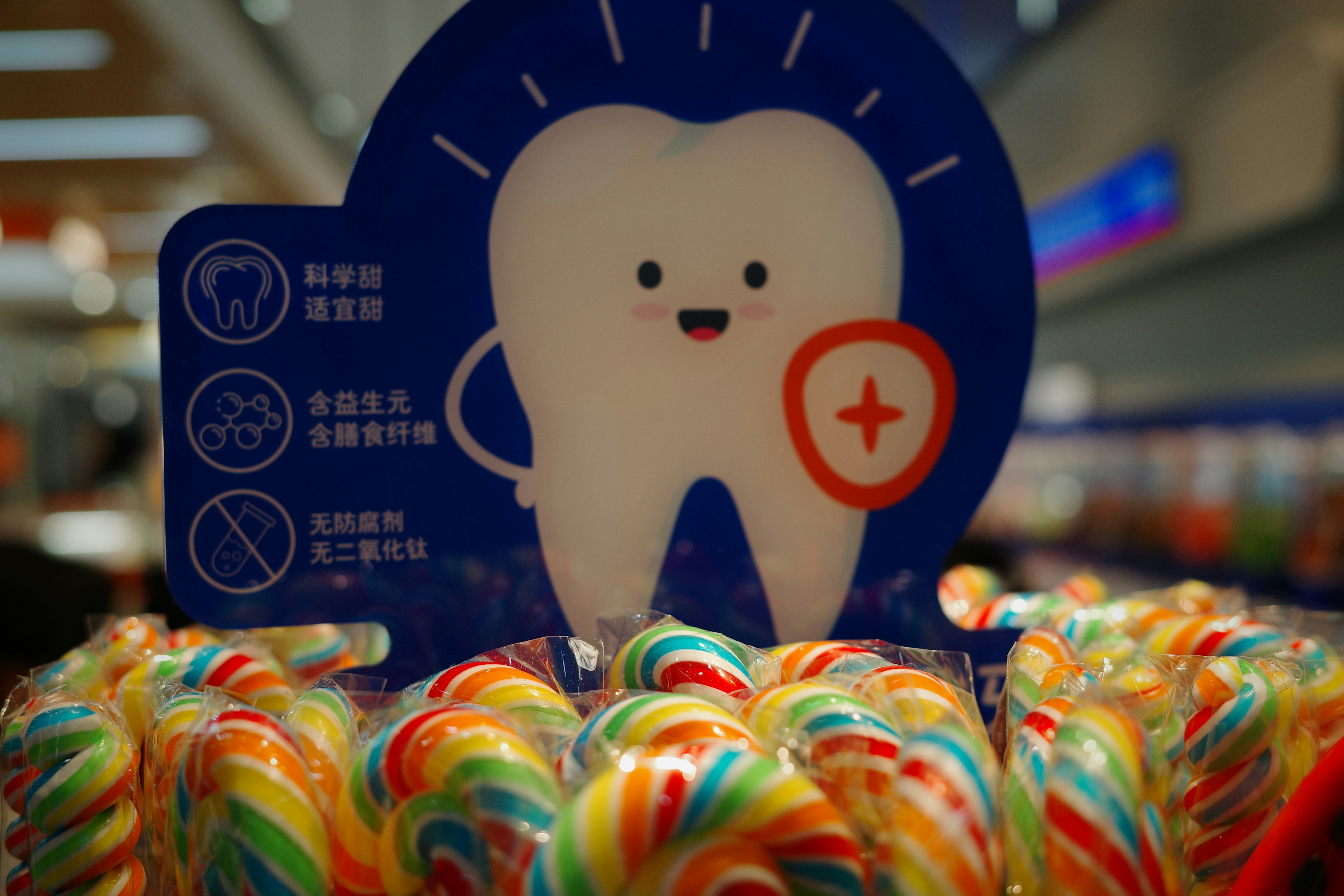 Candy Vigil: A Tooth-Safe Mascot Over a Sea of Rainbow Swirls