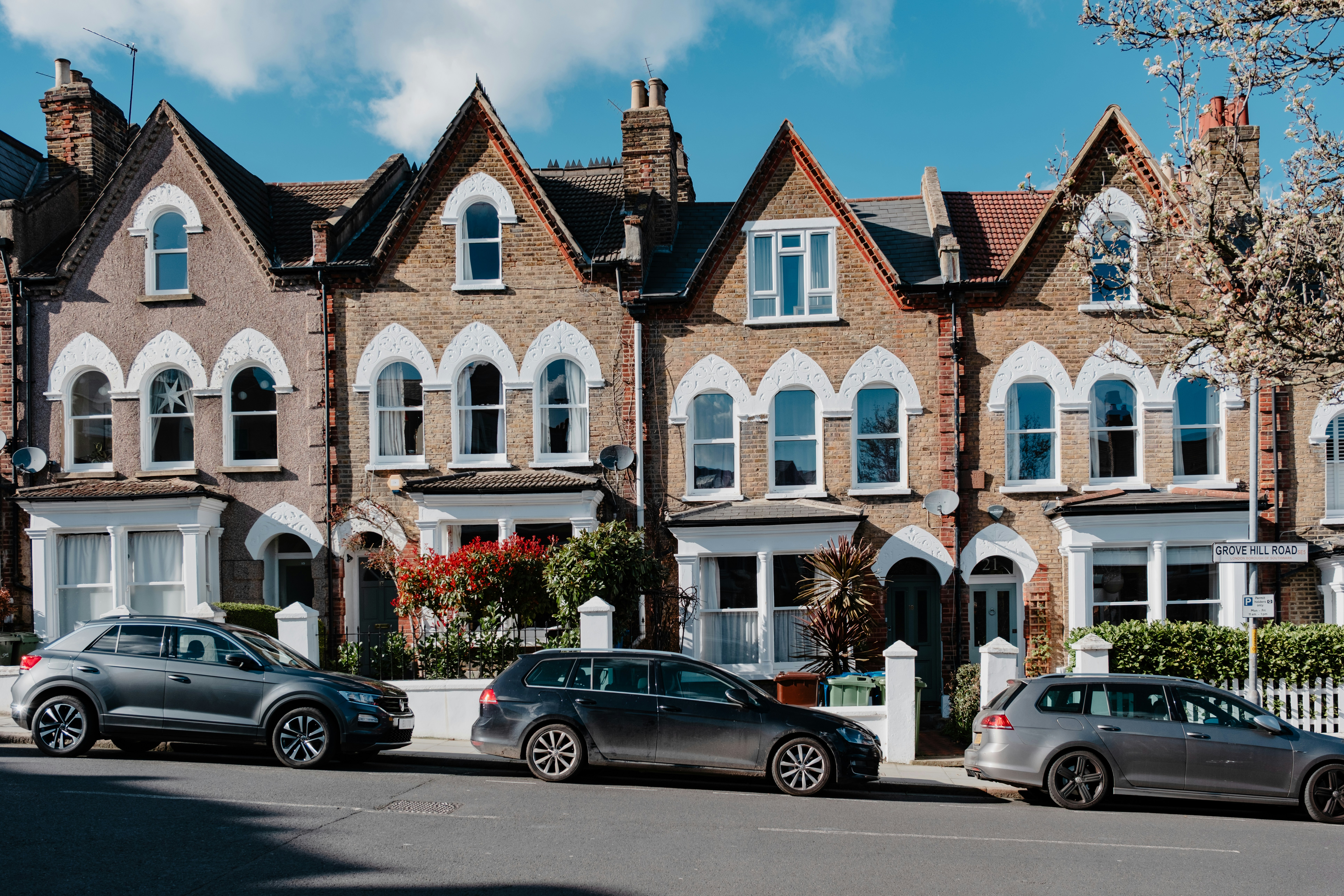 Terraced houses with cars parked on street