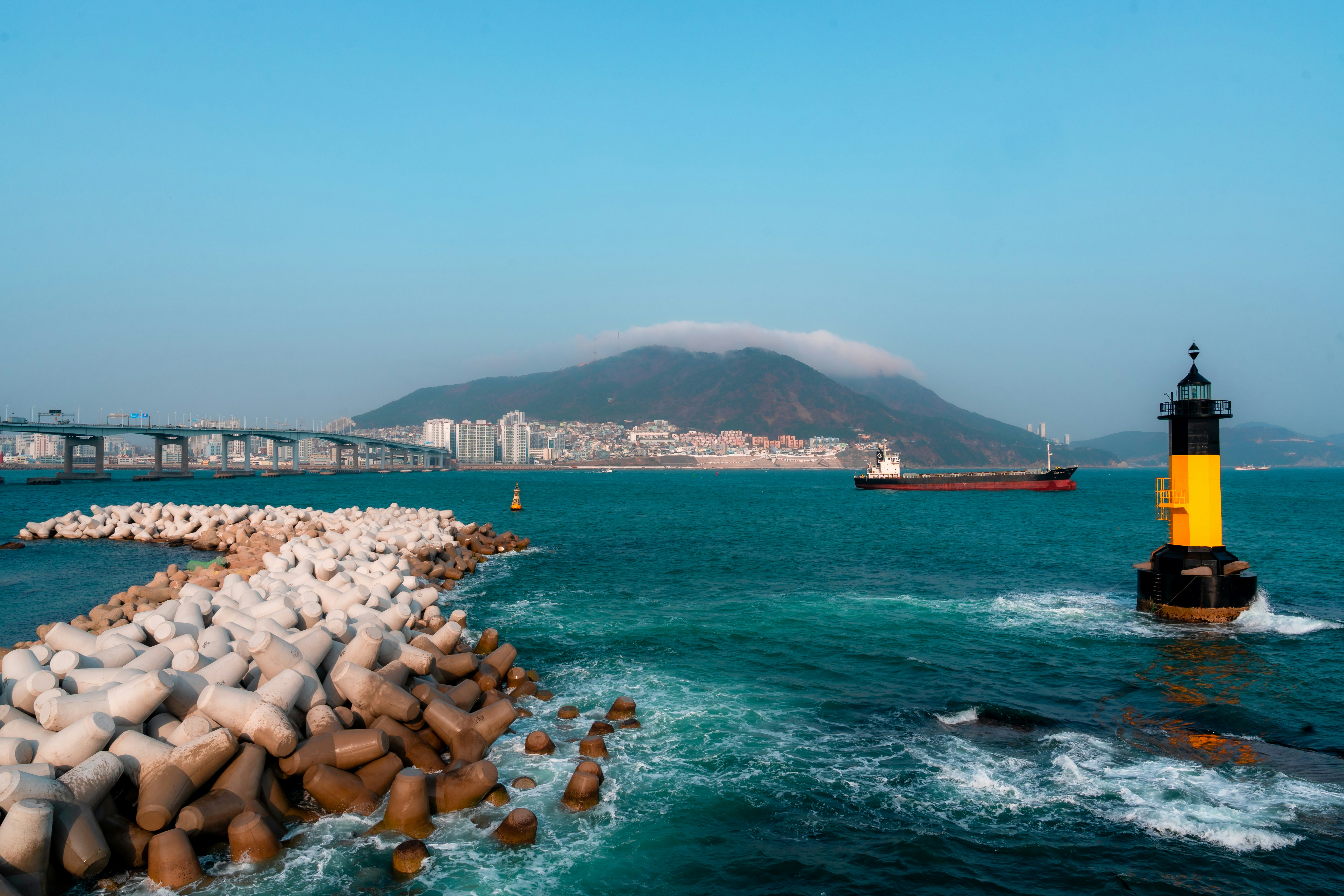 Lighthouse Edge: Turquoise Sea and Distant Coast